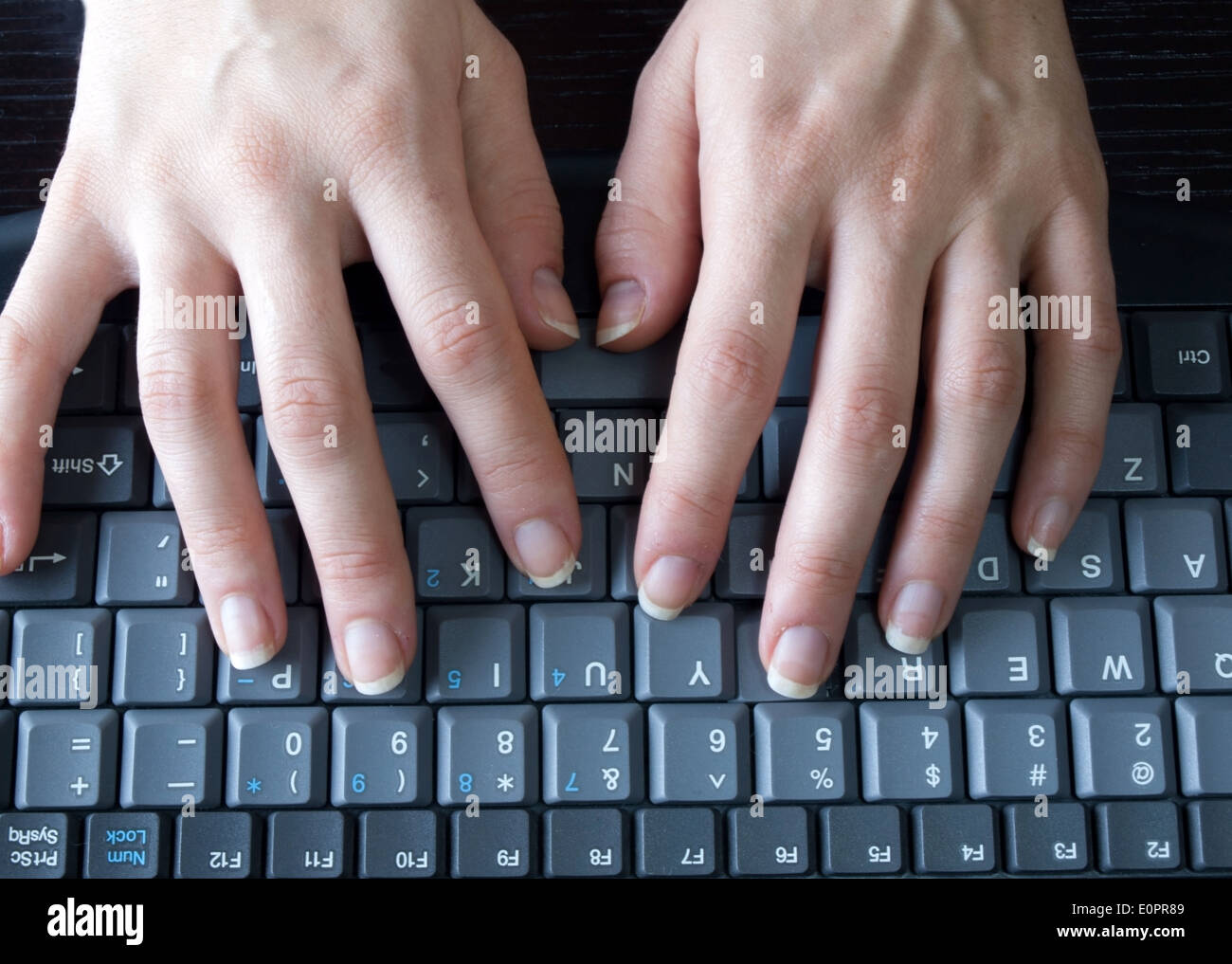 Woman typing on computer keyboard at workplace Stock Photo - Alamy