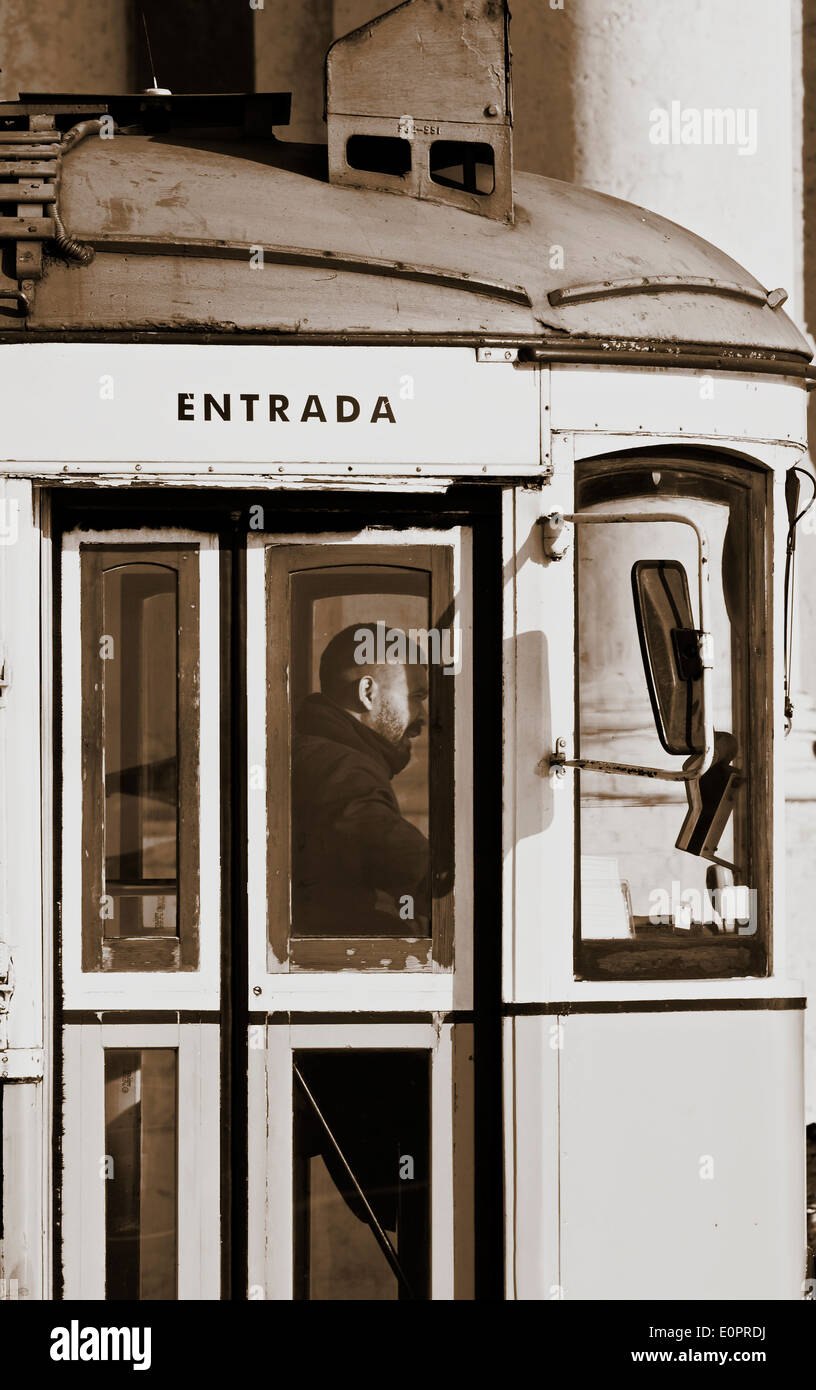 Vintage tram driver seen through doors of tram Lisbon Portugal western ...