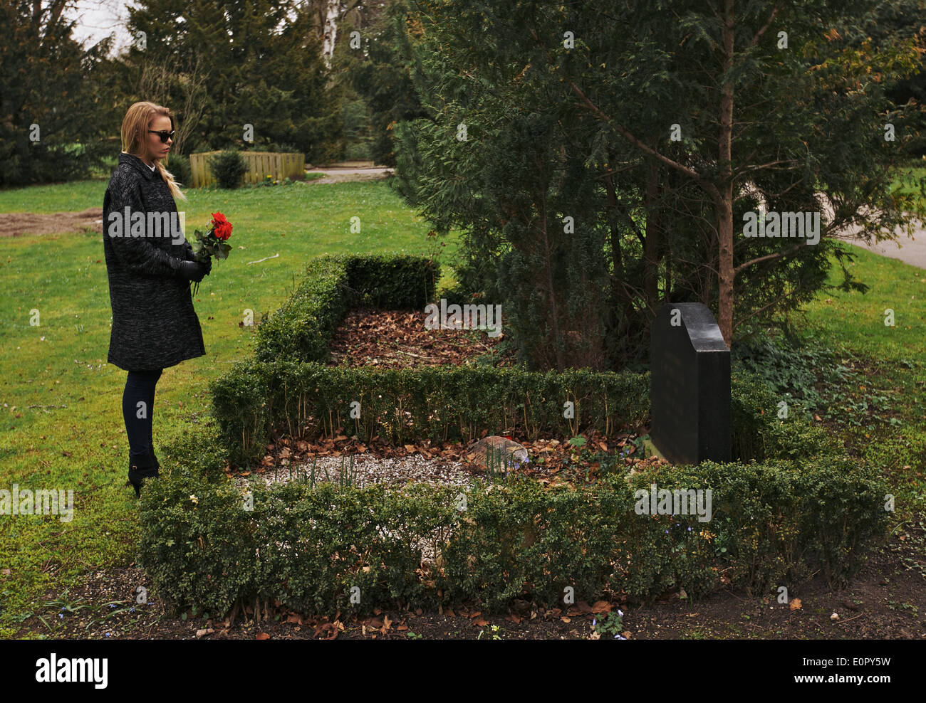 Woman standing grave in cemetery hi-res stock photography and images ...