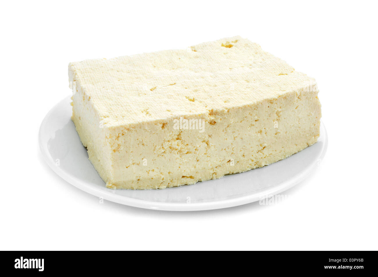 a block of tofu in a plate on a white background Stock Photo - Alamy