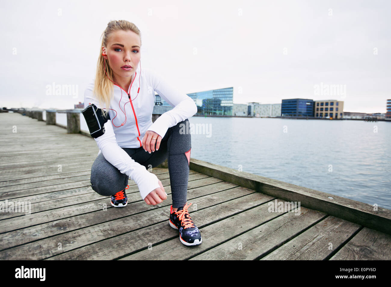 Young woman runner resting after running workout. Female fitness model ...