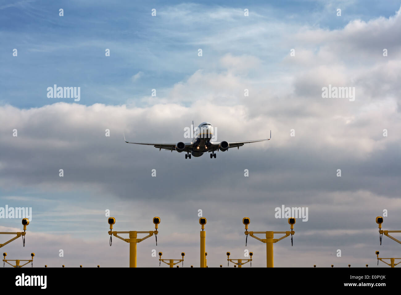 Passenger plane on final approach, with landing lights in view Stock ...