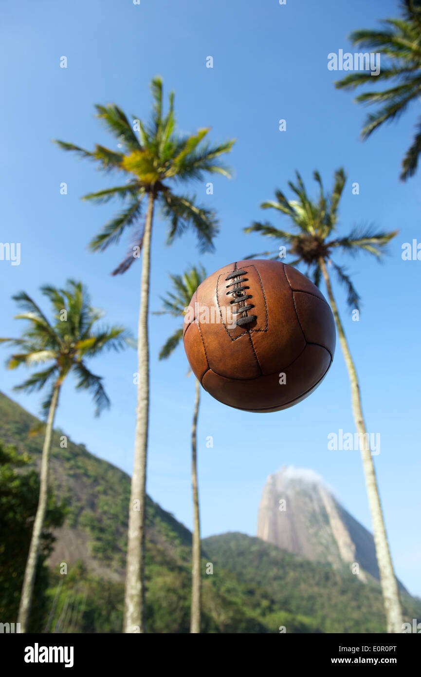 Football soccer ball flying in the palm trees at Pao de Acucar ...