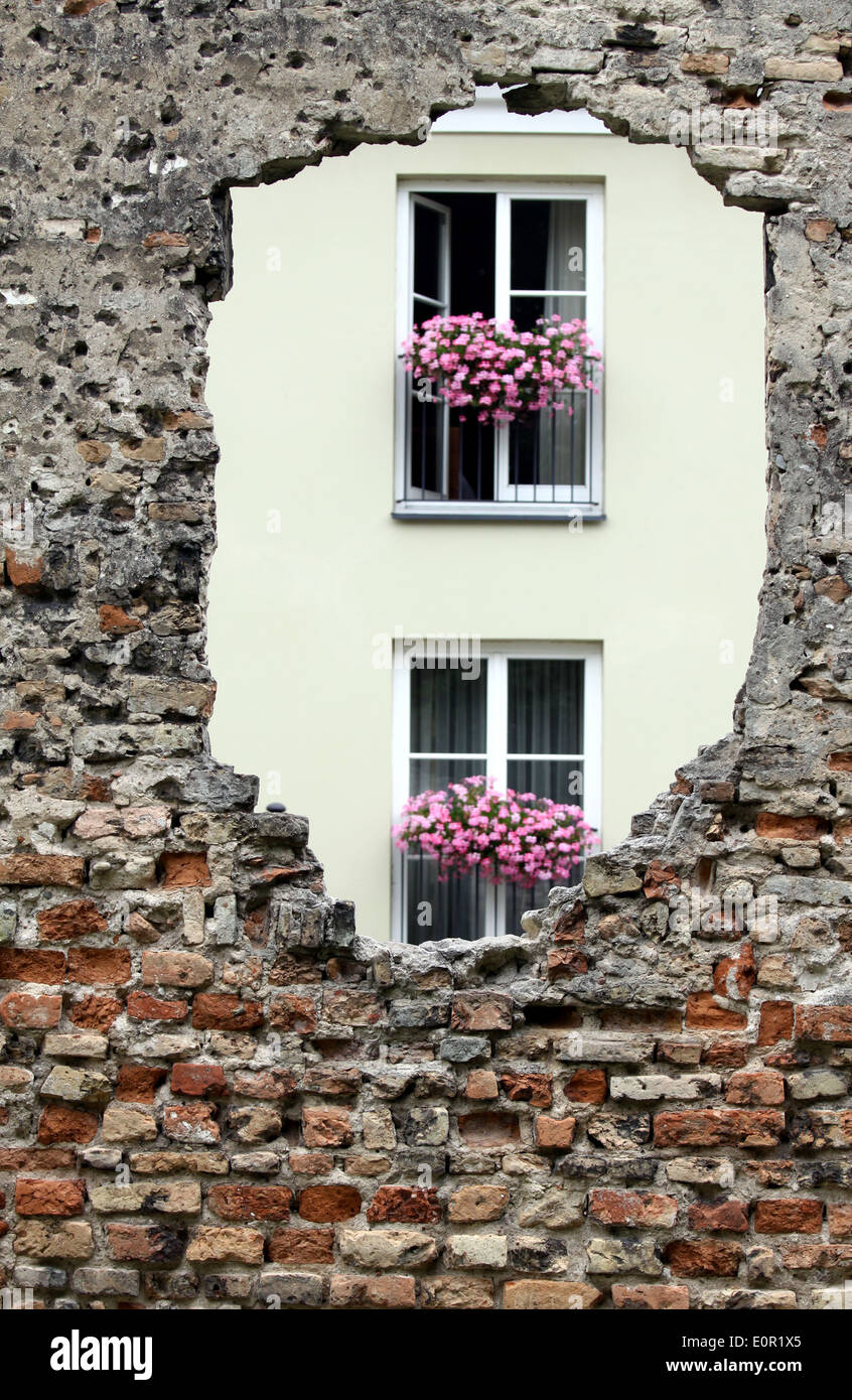 Look at the new building through the hole in the old brick wall Stock ...