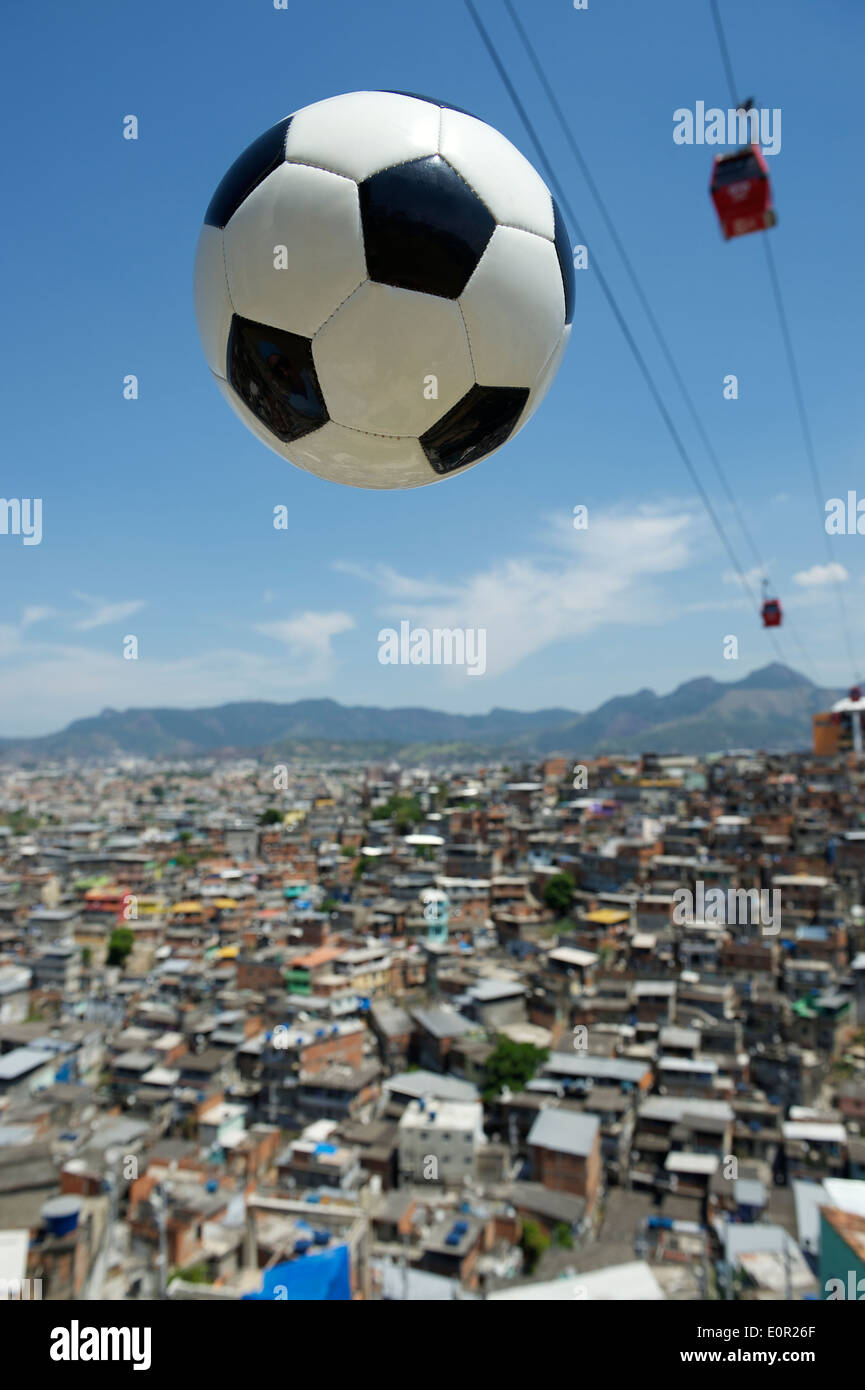 Football soccer ball flying in the sky with red cable cars above Rio de ...