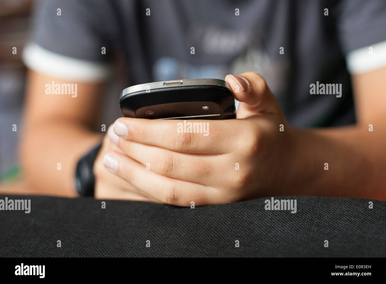 A teenager sends a message with a mobile phone Stock Photo - Alamy