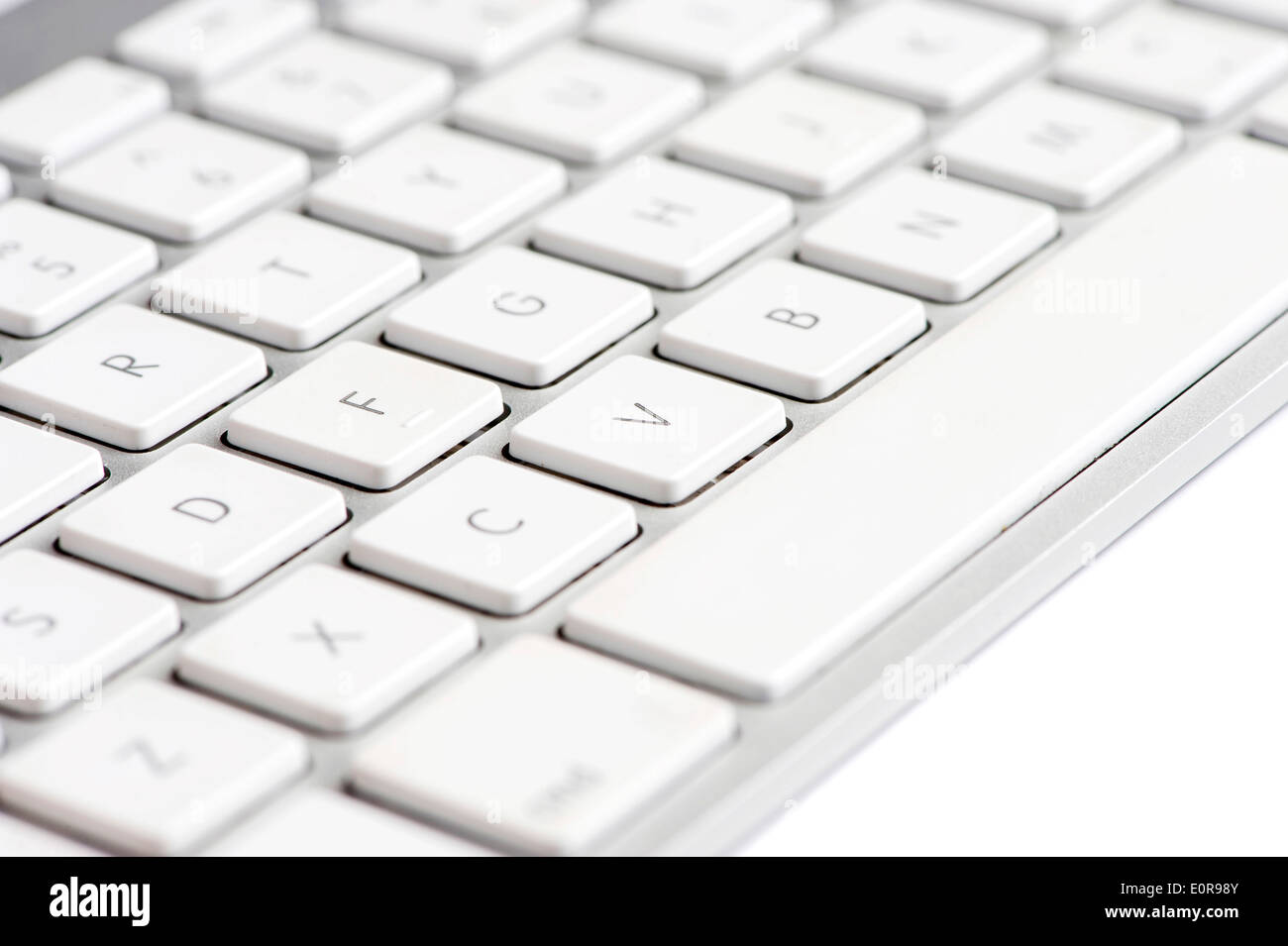 Apple mac white Keyboard focused on the letter V Stock Photo - Alamy