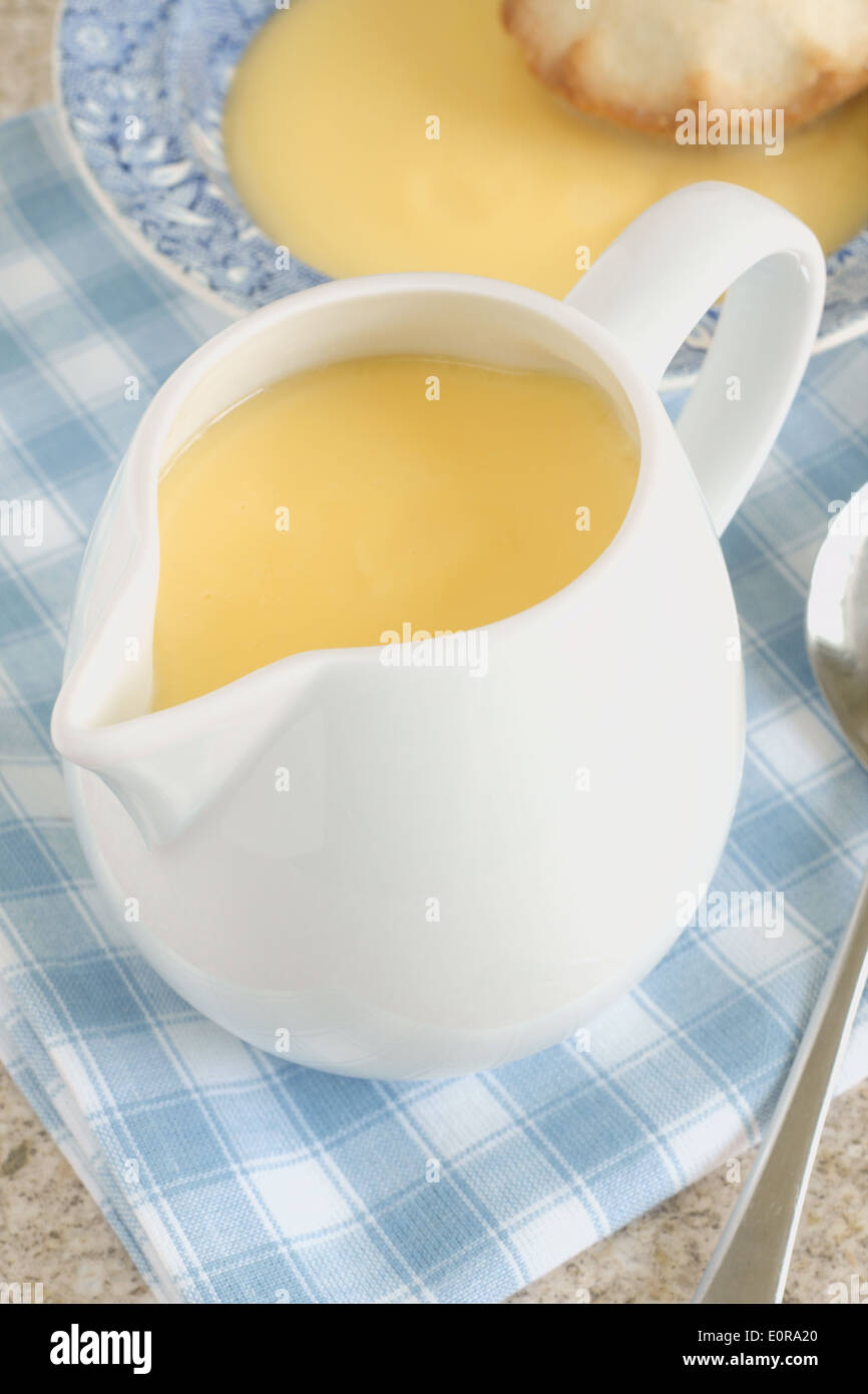 Dessert pouring custard on table hi-res stock photography and images ...