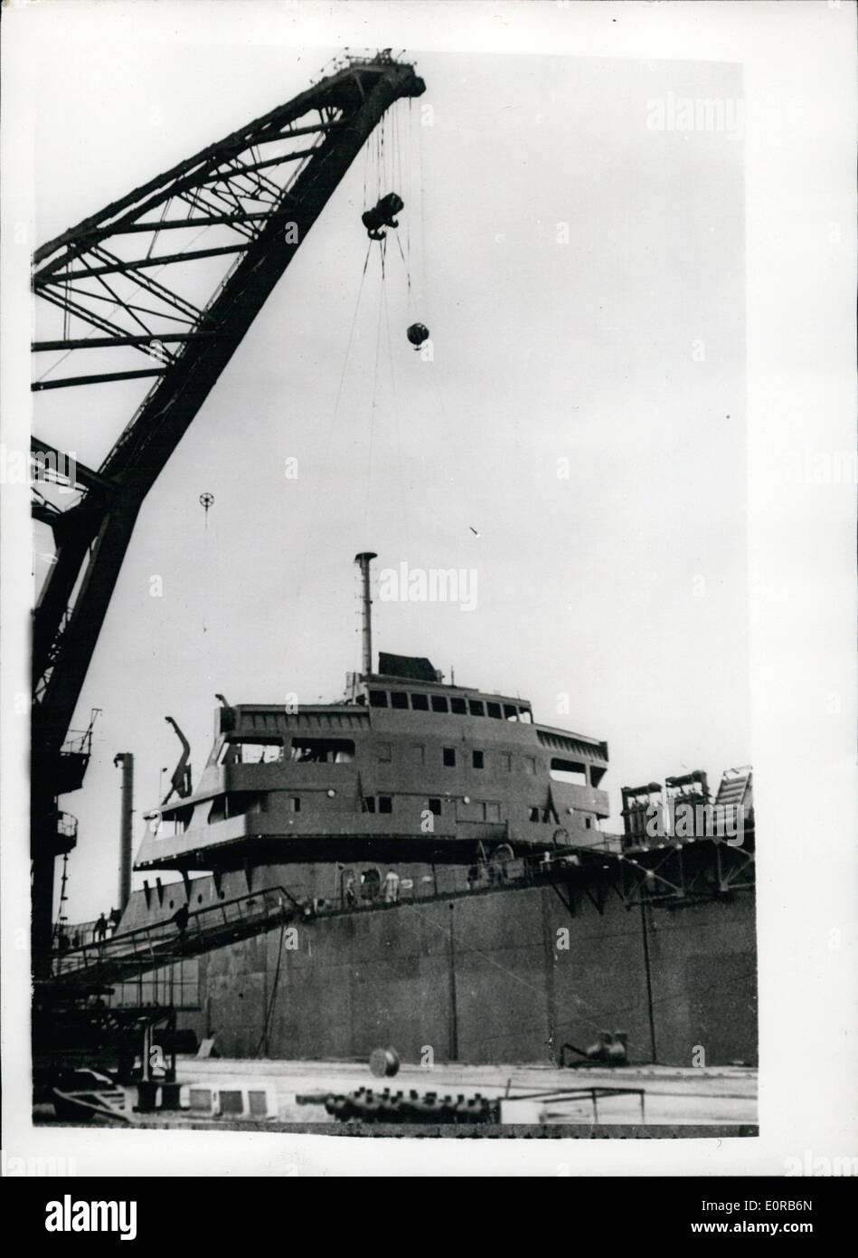 Dec. 12, 1958 - Center part of oil tanker placed aboard by crane; A 250 ...