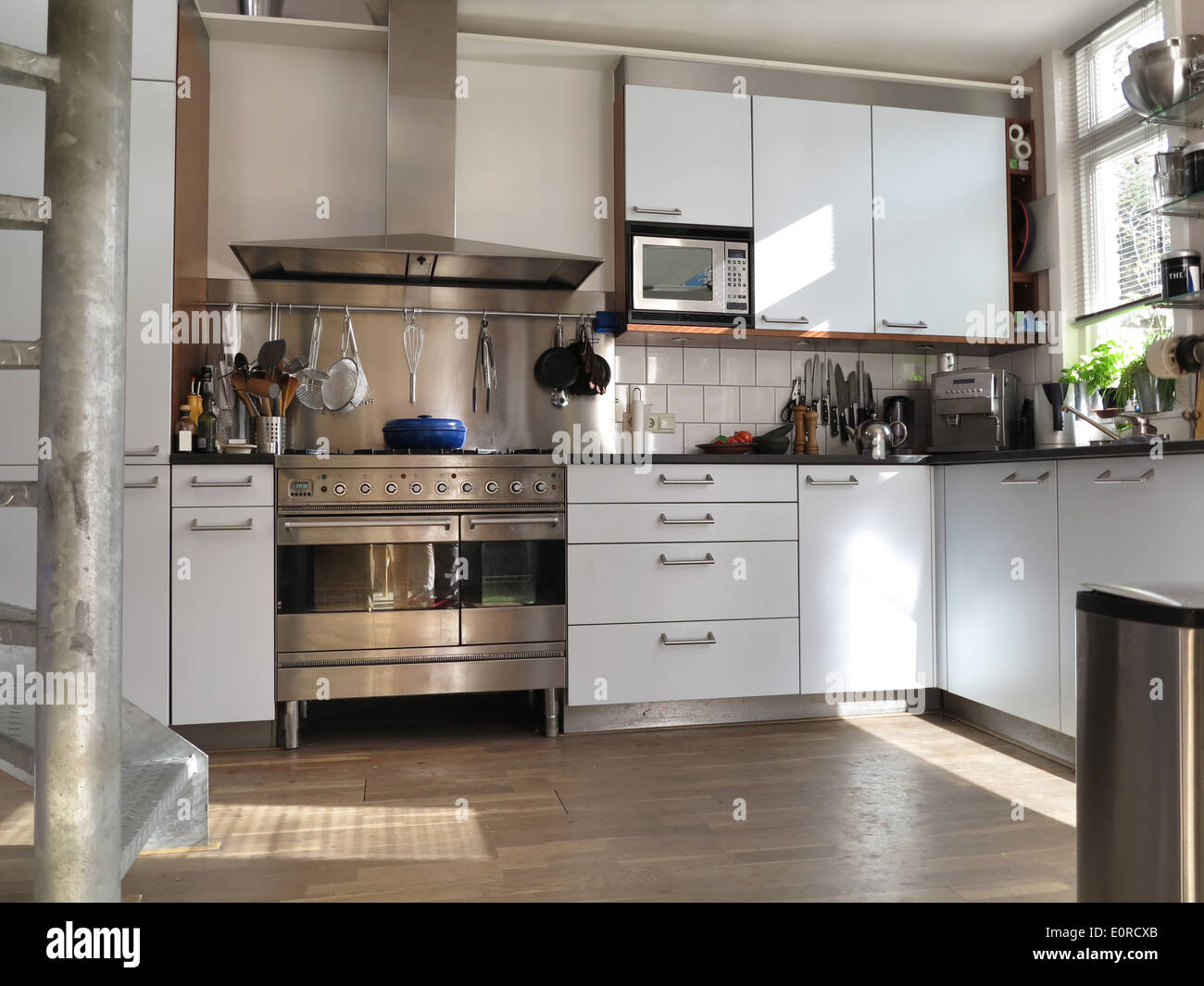 Modern kitchen interior with sunlight on wooden floor Stock Photo - Alamy