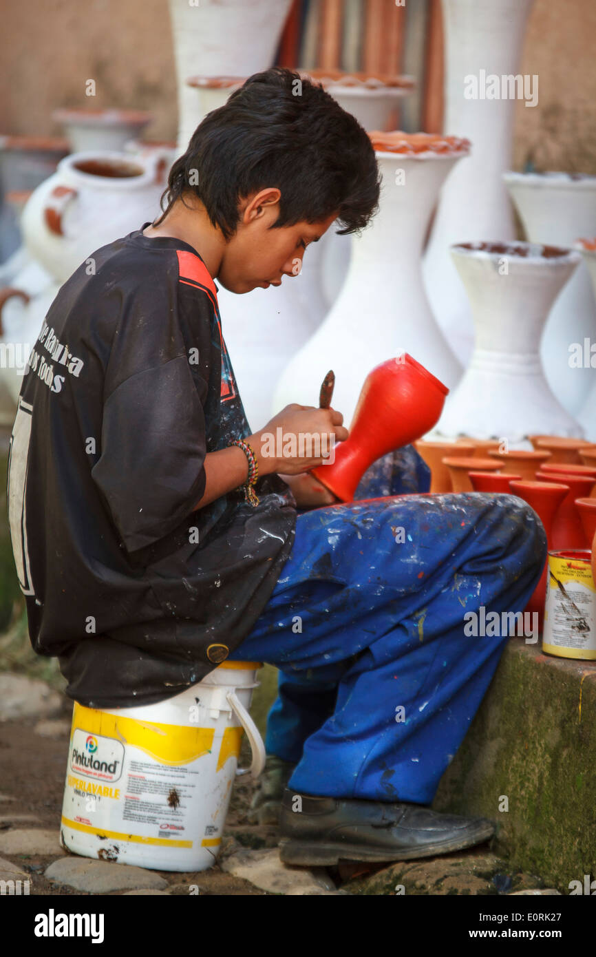 Boy painting Flower pots Stock Photo - Alamy