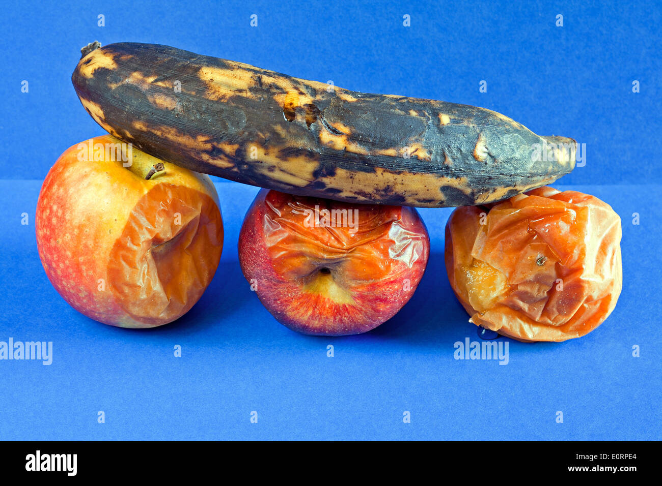 Very ripe plantain and apples in various stages of discomposure, on ...