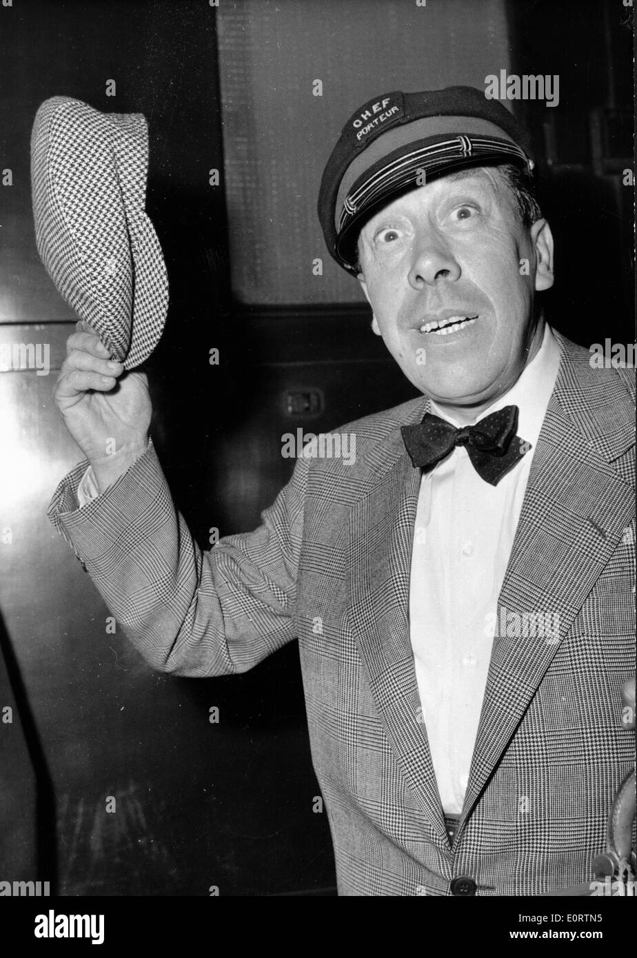 Actor Fernandel tips his hat Stock Photo - Alamy