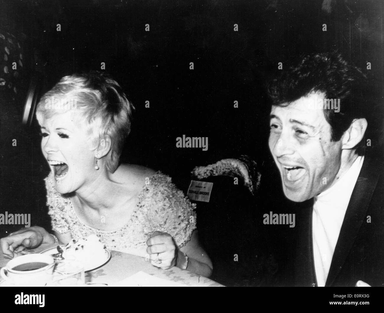 Singer Eddie Fisher laughs at dinner Stock Photo - Alamy