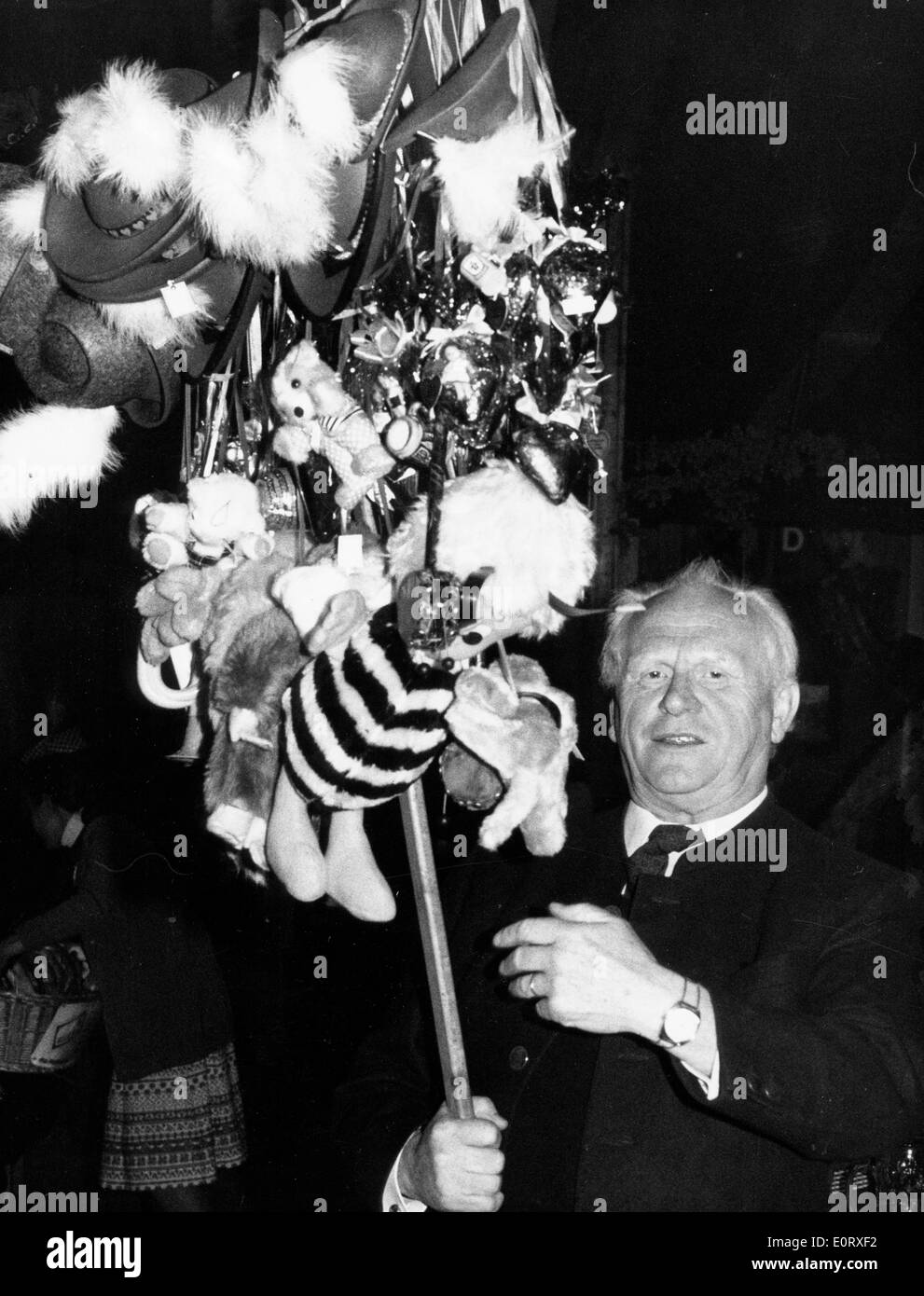 Actor Gert Frobe carrying items to sell Stock Photo - Alamy