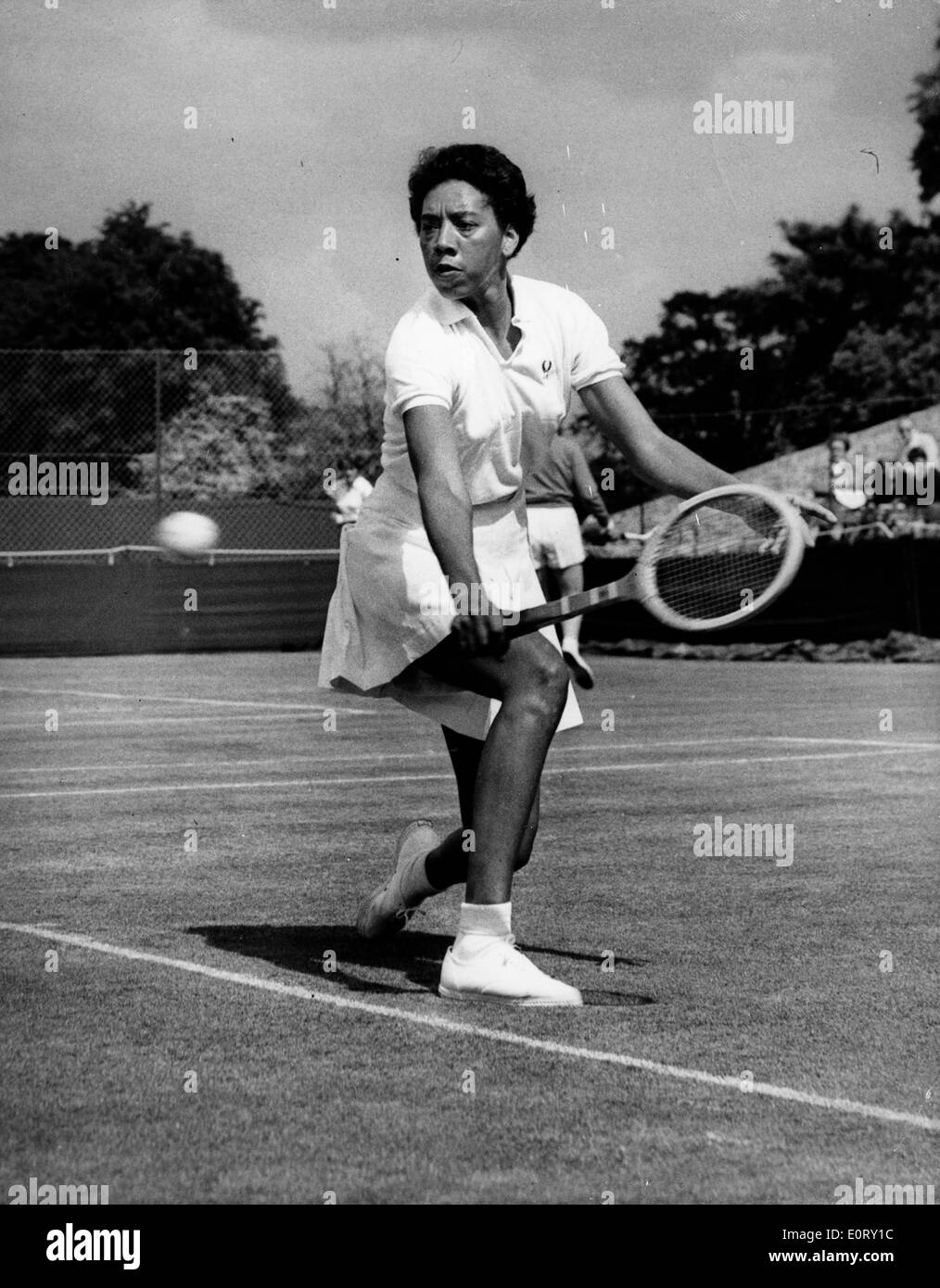 Tennis pro Althea Gibson goes after ball during match Stock Photo - Alamy