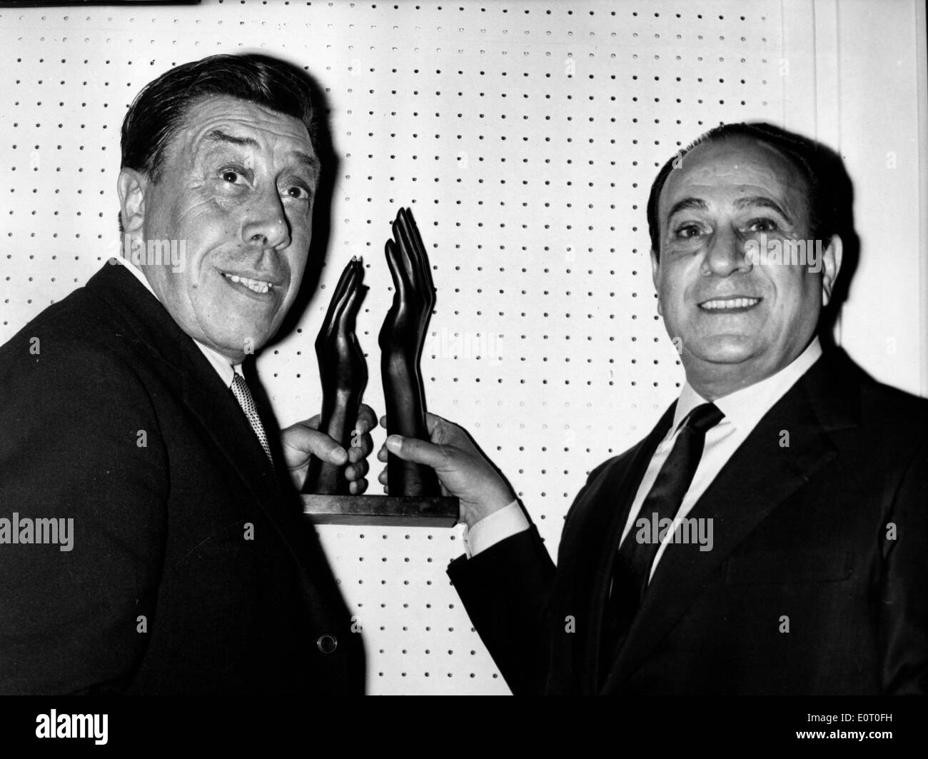 Actor Fernandel holds up award Stock Photo - Alamy