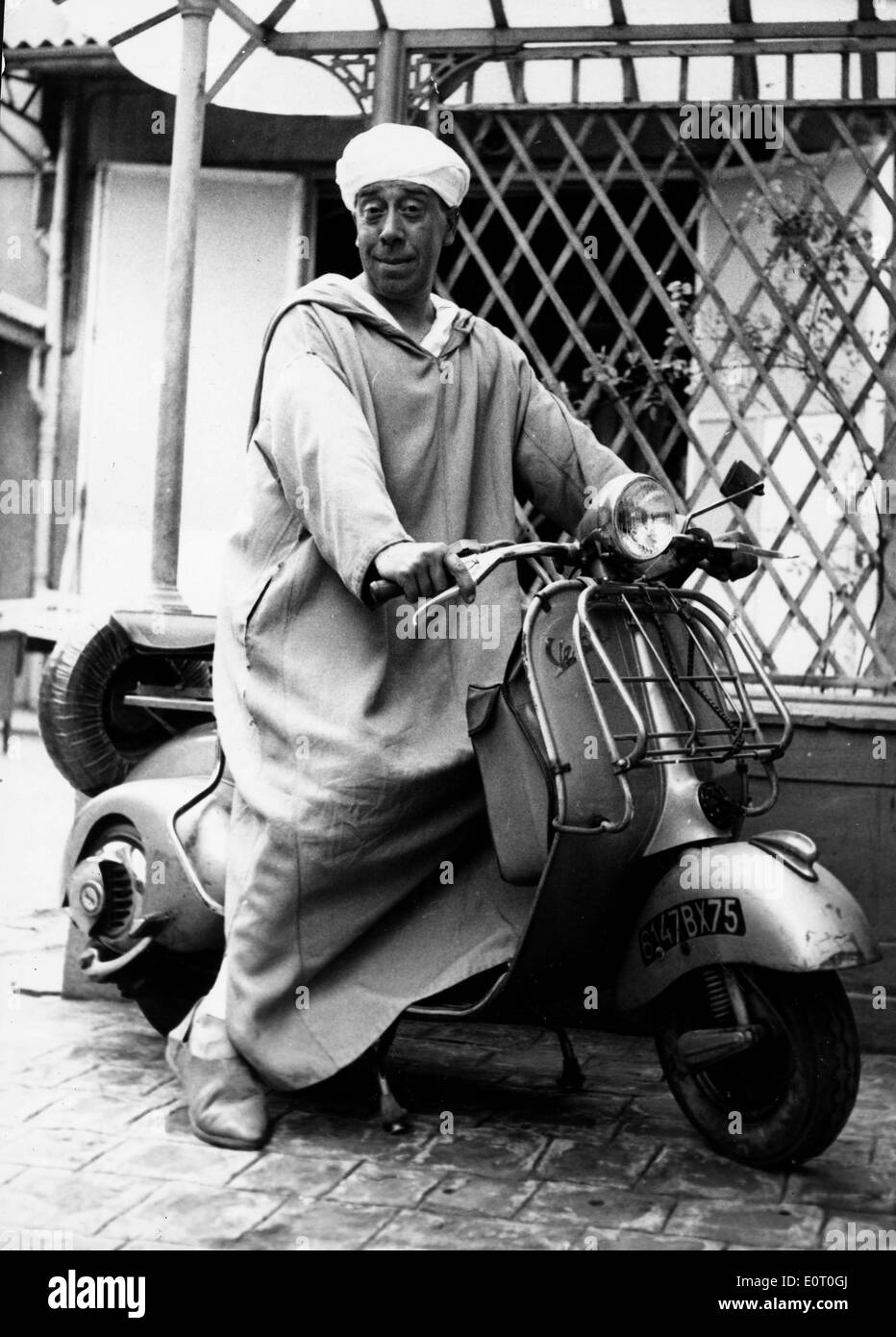 Actor Fernandel riding a vespa Stock Photo - Alamy