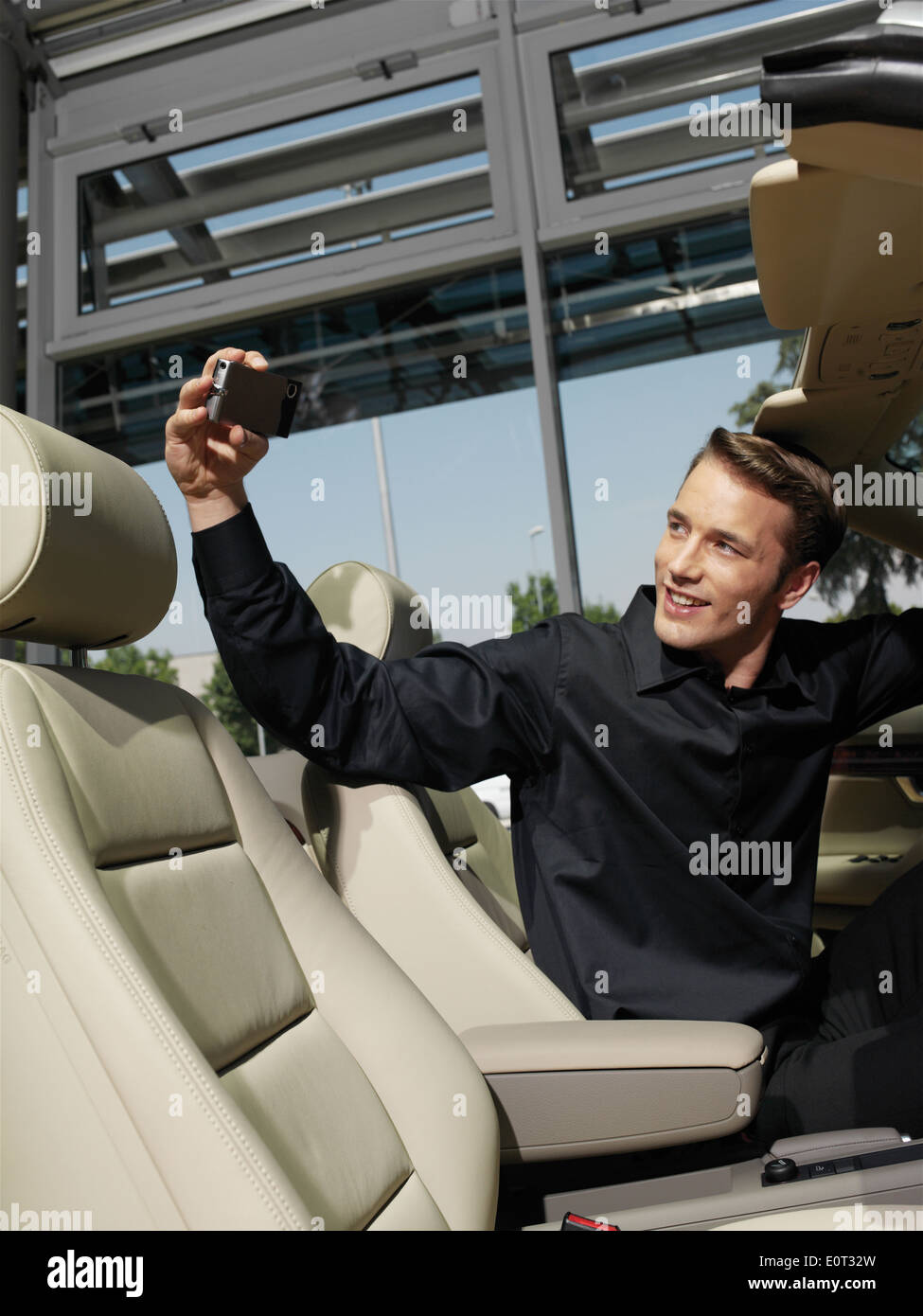 Handsome young guy taking photo with camera - Outdoor Stock Photo - Alamy