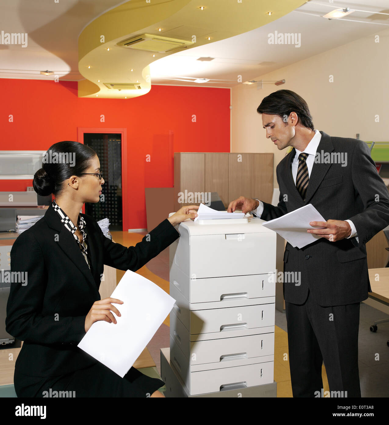 young businesswoman making copies on the photocopy machine at the ...