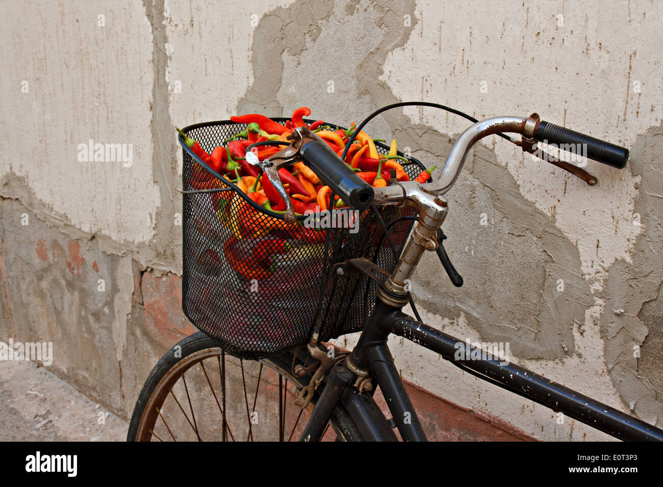 Old rusty bicycle with colorful peppers in basket Stock Photo - Alamy