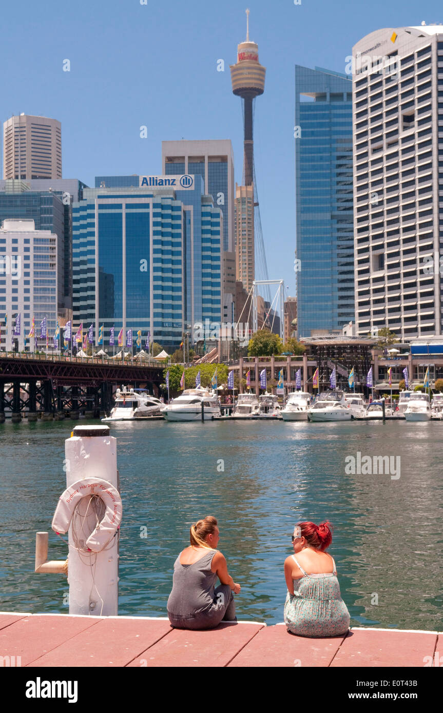 Two girls enjoy a chat in the sunshine on the dockside at Darling ...