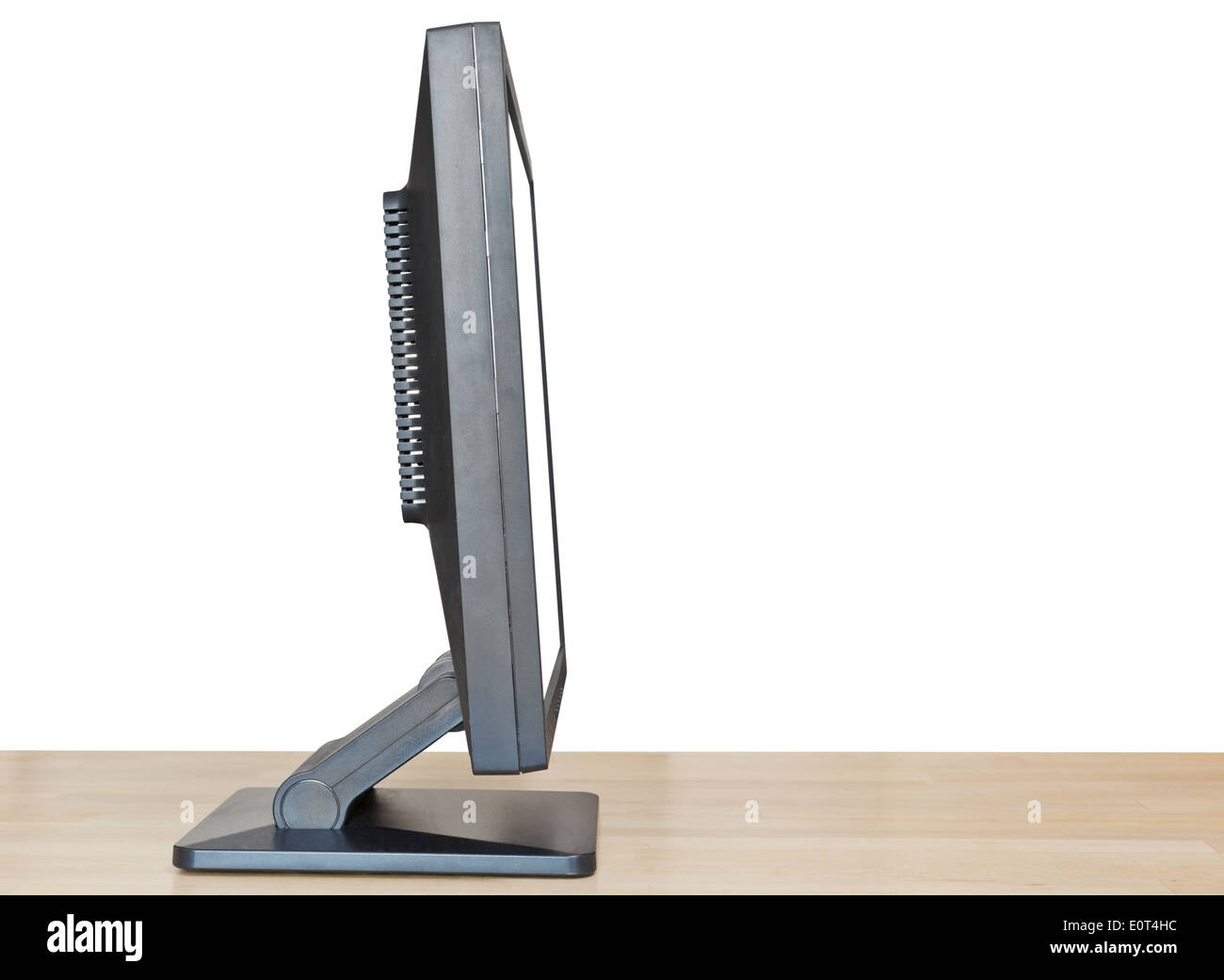 side view of computer display with cut out screen on wooden table ...