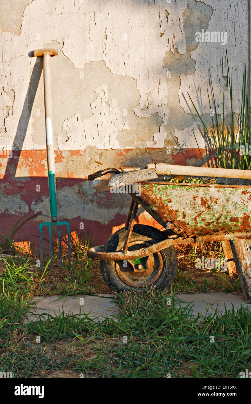 Gardening tools in old rusty wheelbarrow Stock Photo - Alamy