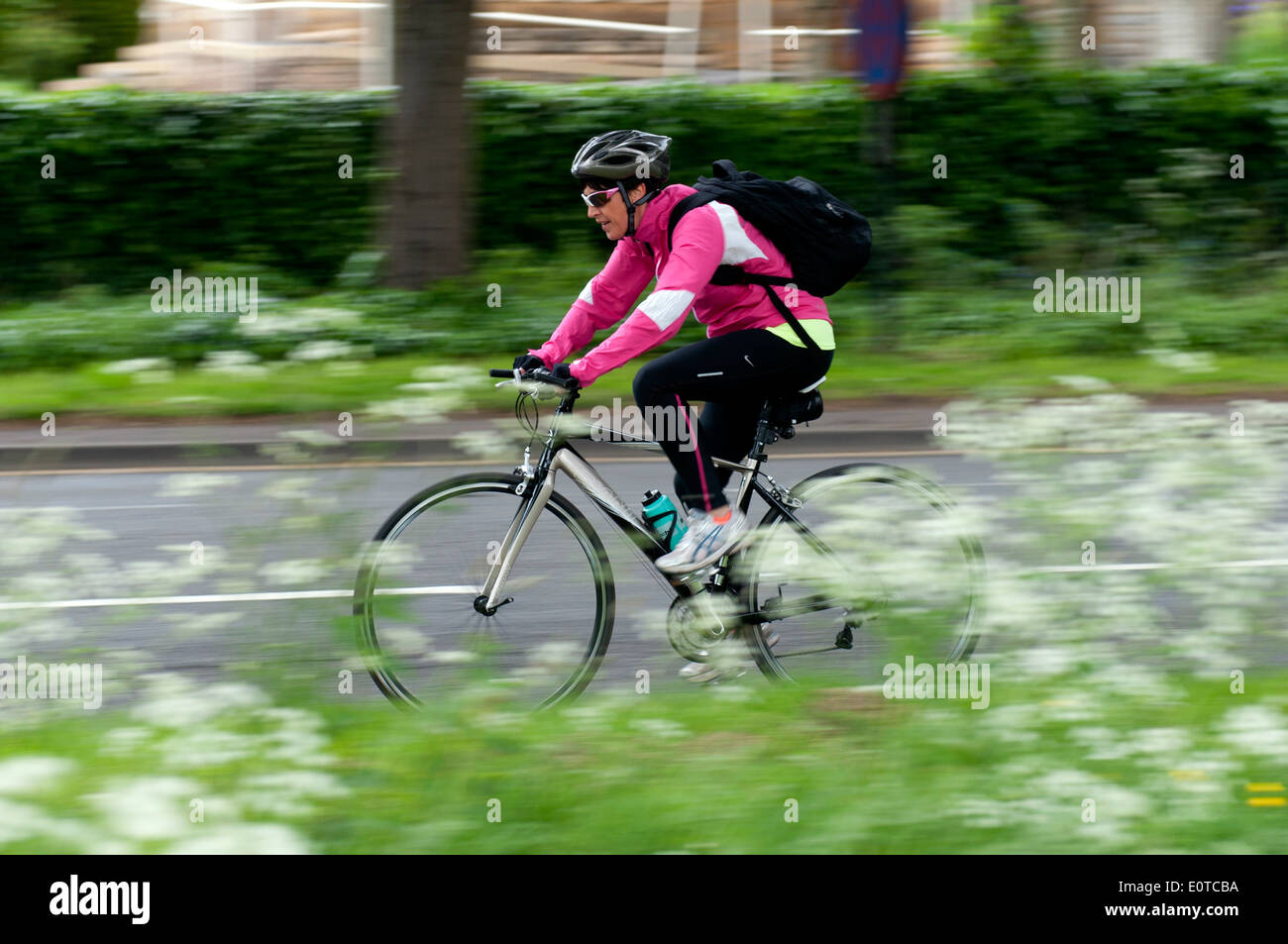 Woman cyclist at speed, side view, in the Stratford 220 Triathlon Stock ...