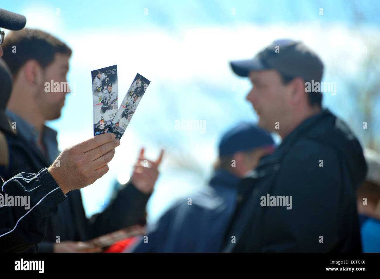 A man selling tickets outside a sports event in Canada Stock Photo - Alamy