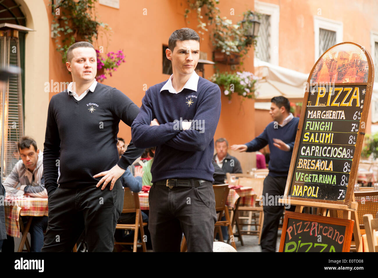 Waiters trying to attract customers at a pizza restaurant or pizzeria ...