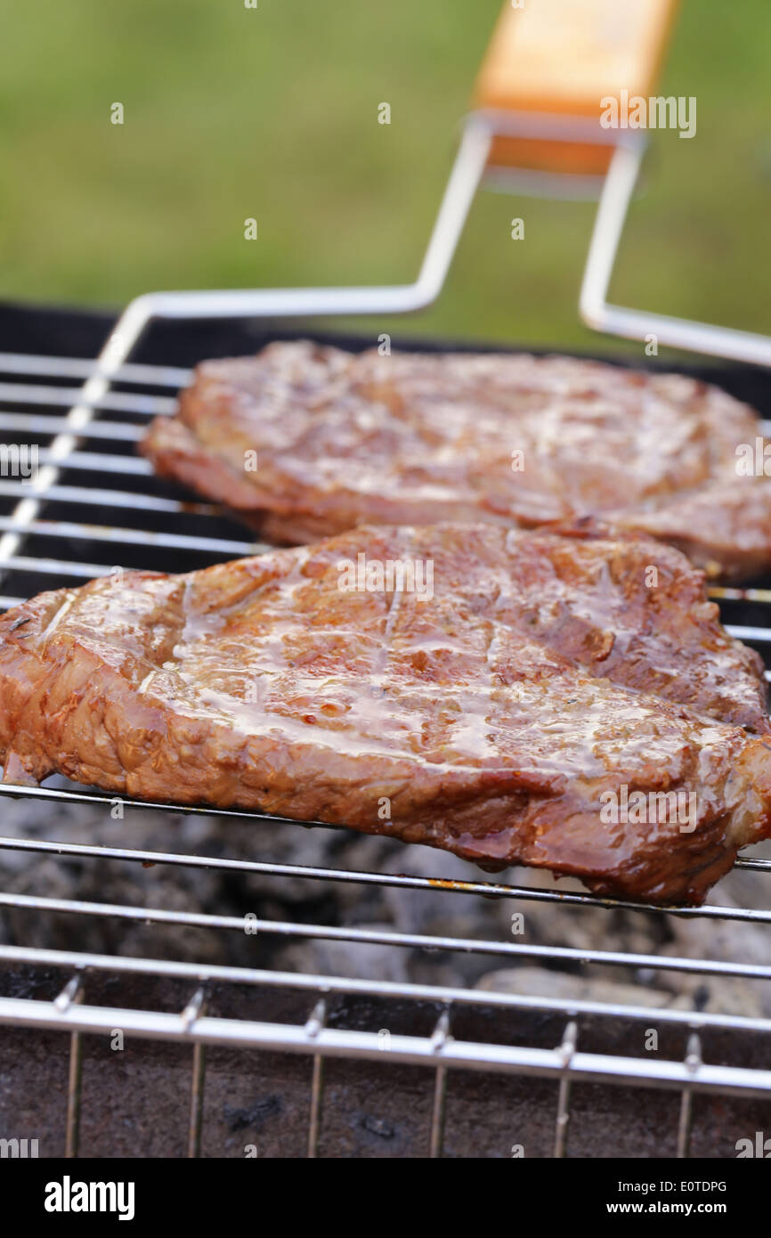 beef steak grilled on a barbecue outdoors Stock Photo - Alamy