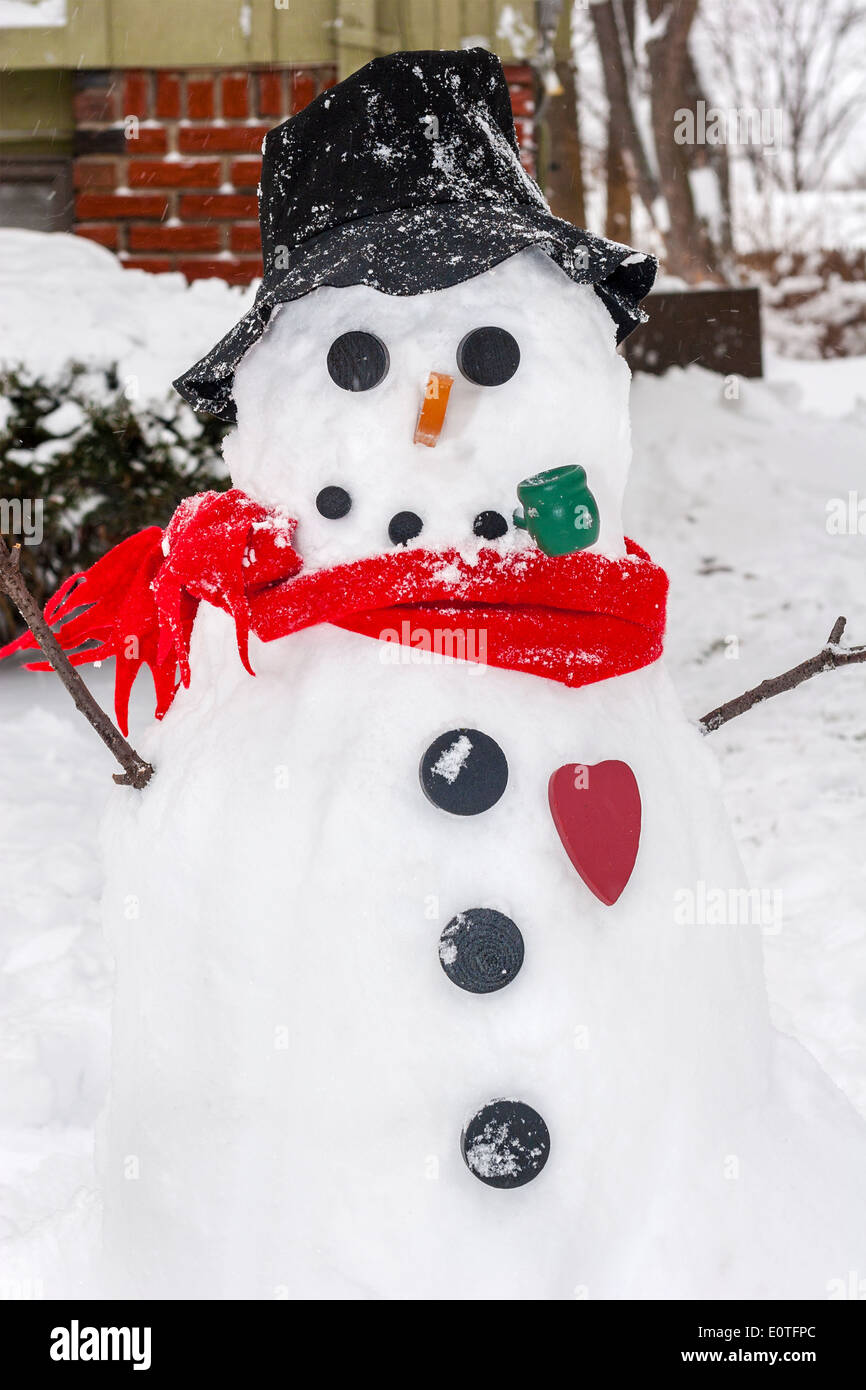 A Snowman and falling snow Stock Photo - Alamy