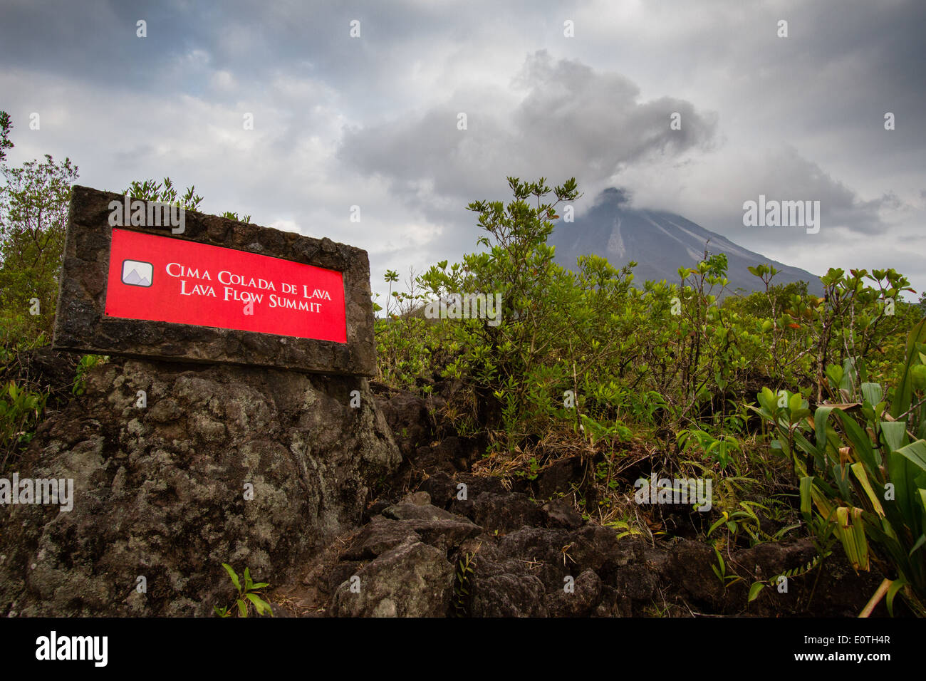 Arenal volcano from the 1968 eruption lava flow - summit marker sign ...
