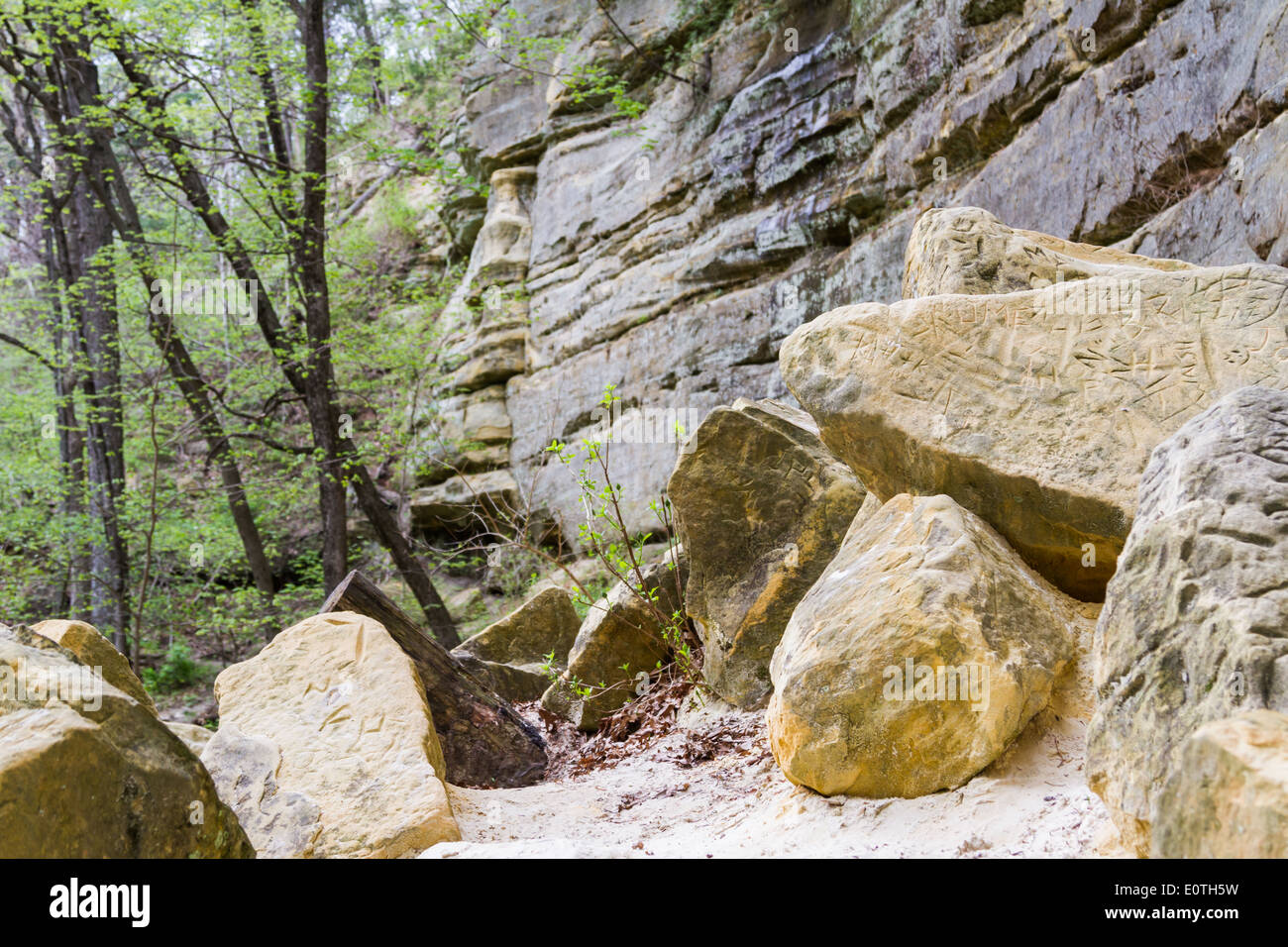 large sandstone cliffs with rocks that have fallen in the past turning ...