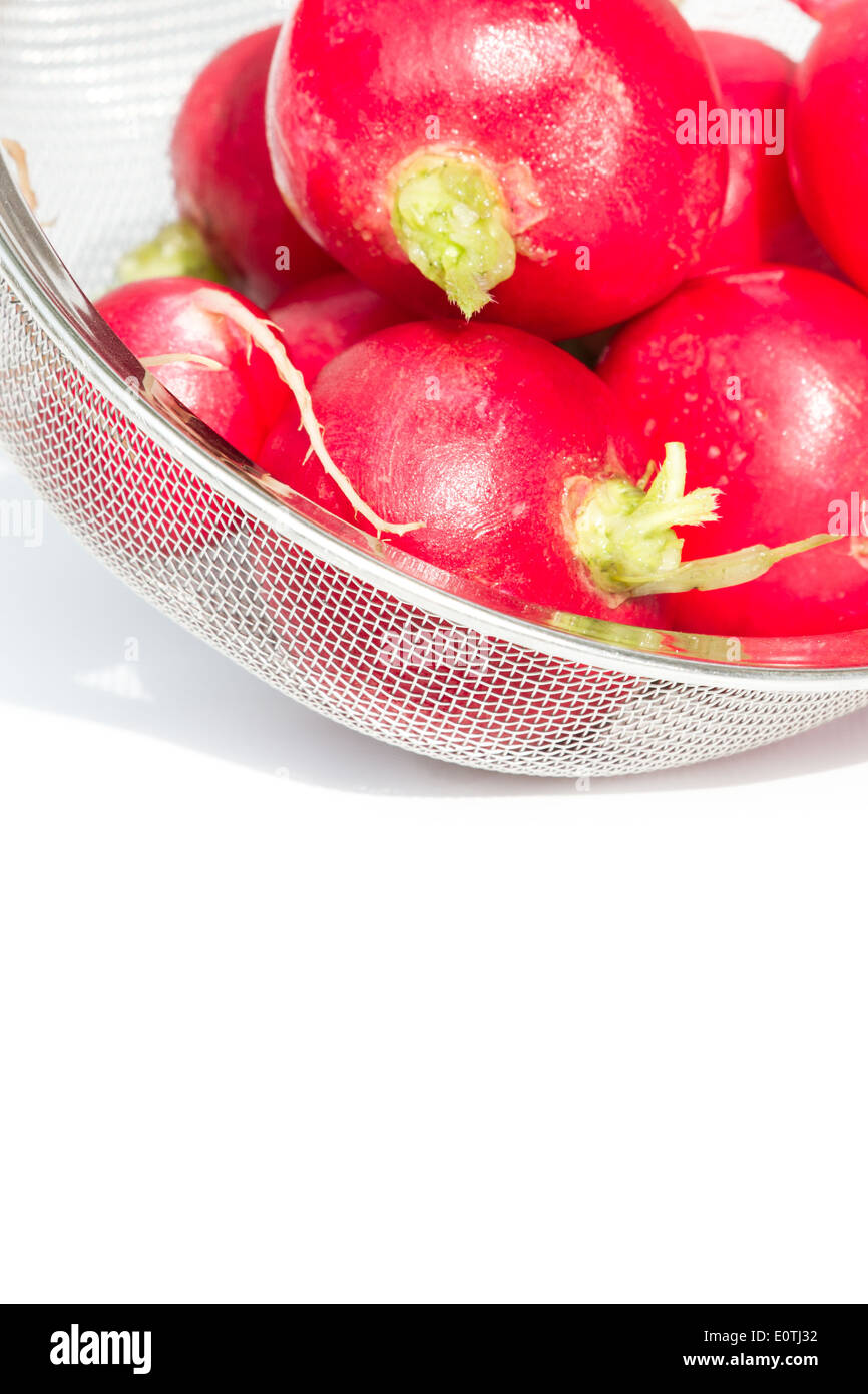 fresh clean red radishes in a strainer over a white background Stock ...
