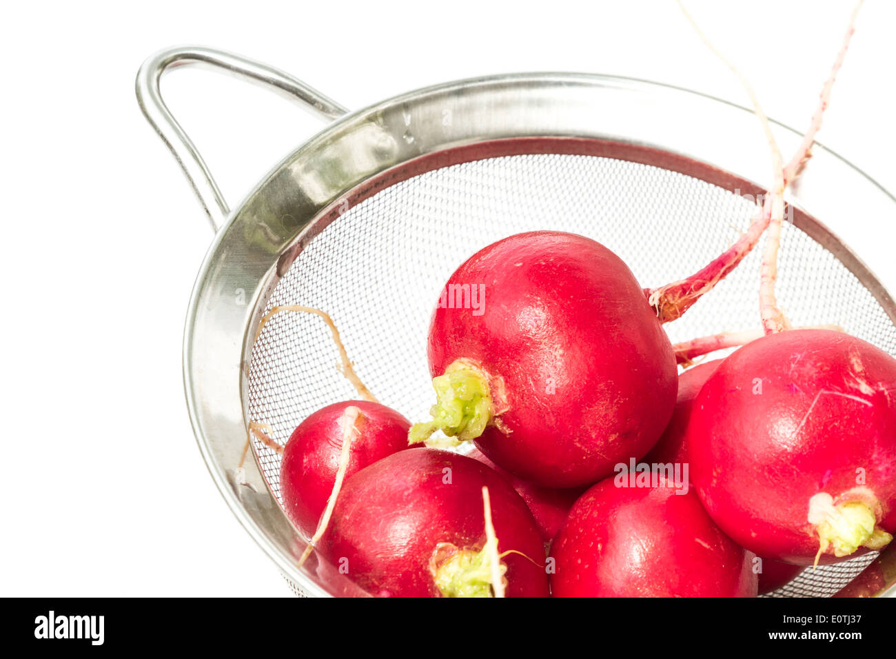 fresh clean red radishes in a strainer over a white background Stock ...