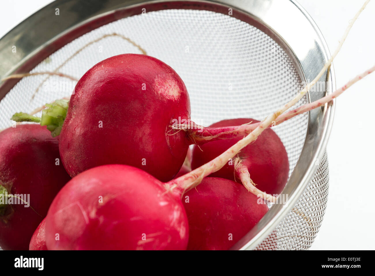 fresh clean red radishes in a strainer over a white background Stock ...
