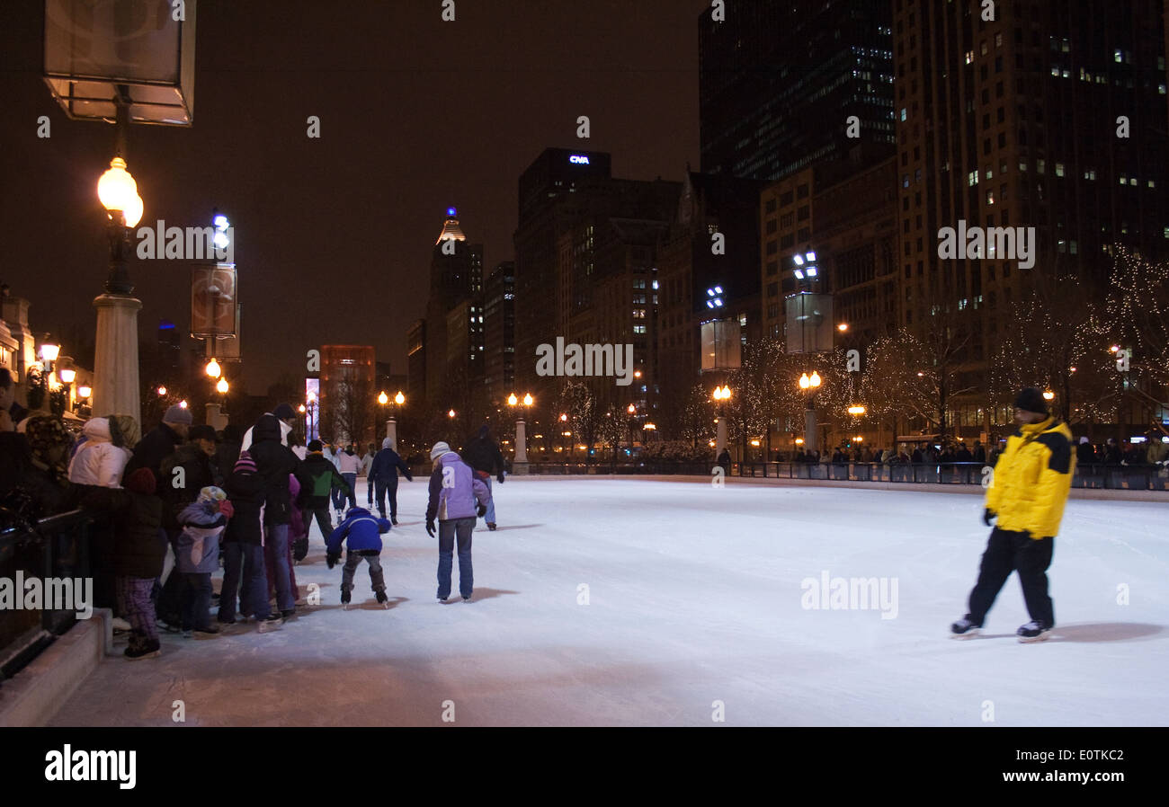 People jump to the ice rink while an instructor watches closely Stock ...