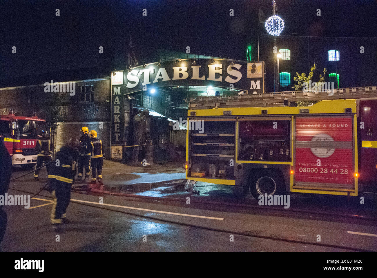 London, UK. 20th May 2014. Firemen work around a Fire Engine at the ...