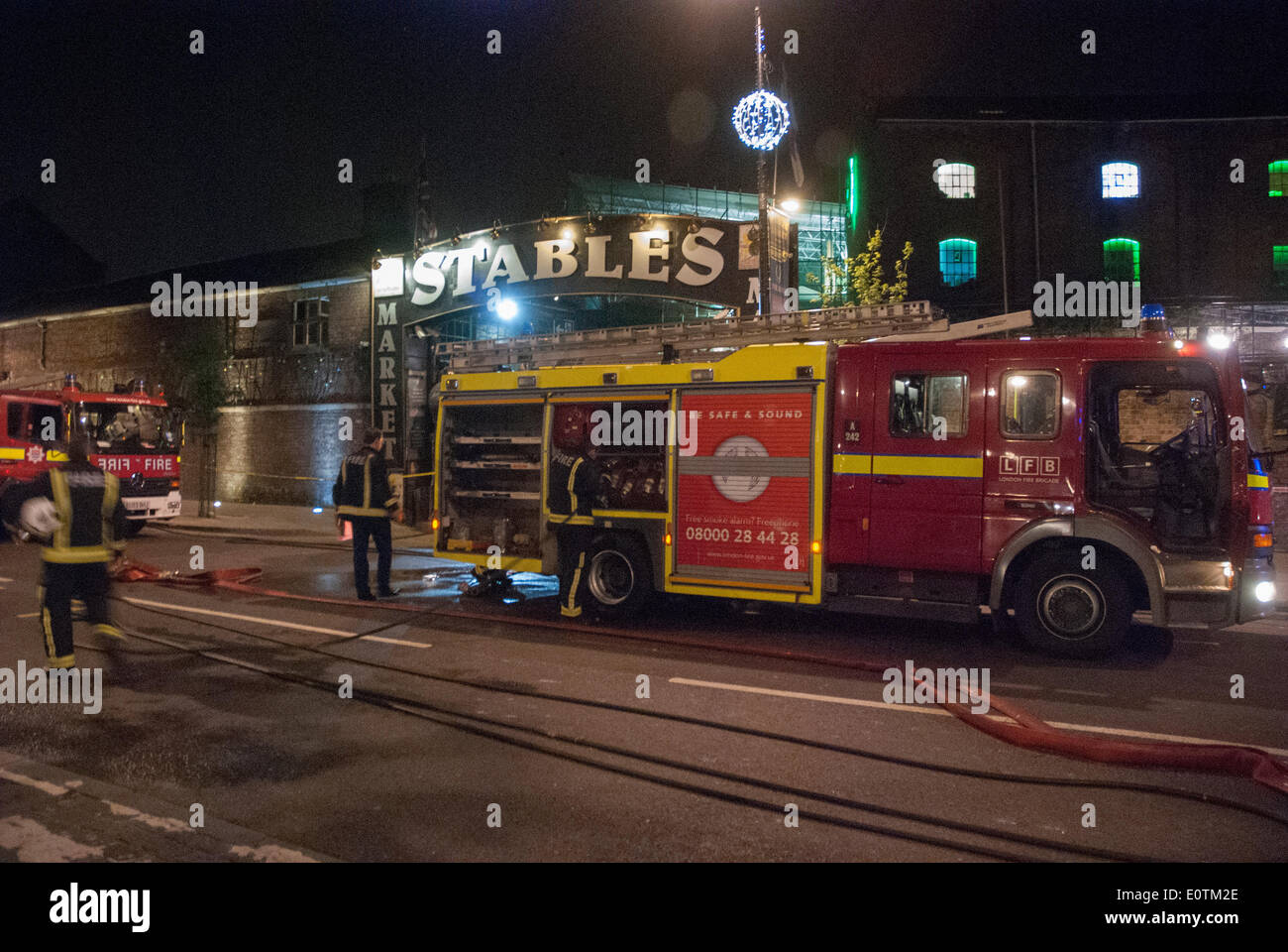 London, UK. 20th May 2014. Firemen work around a Fire Engine at the ...