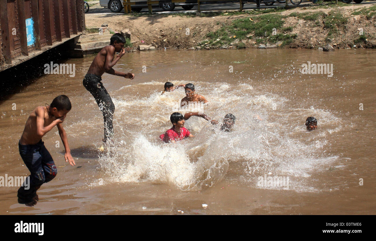 Lahore. 19th May, 2014. Boys swim in a canal during a hot day in ...