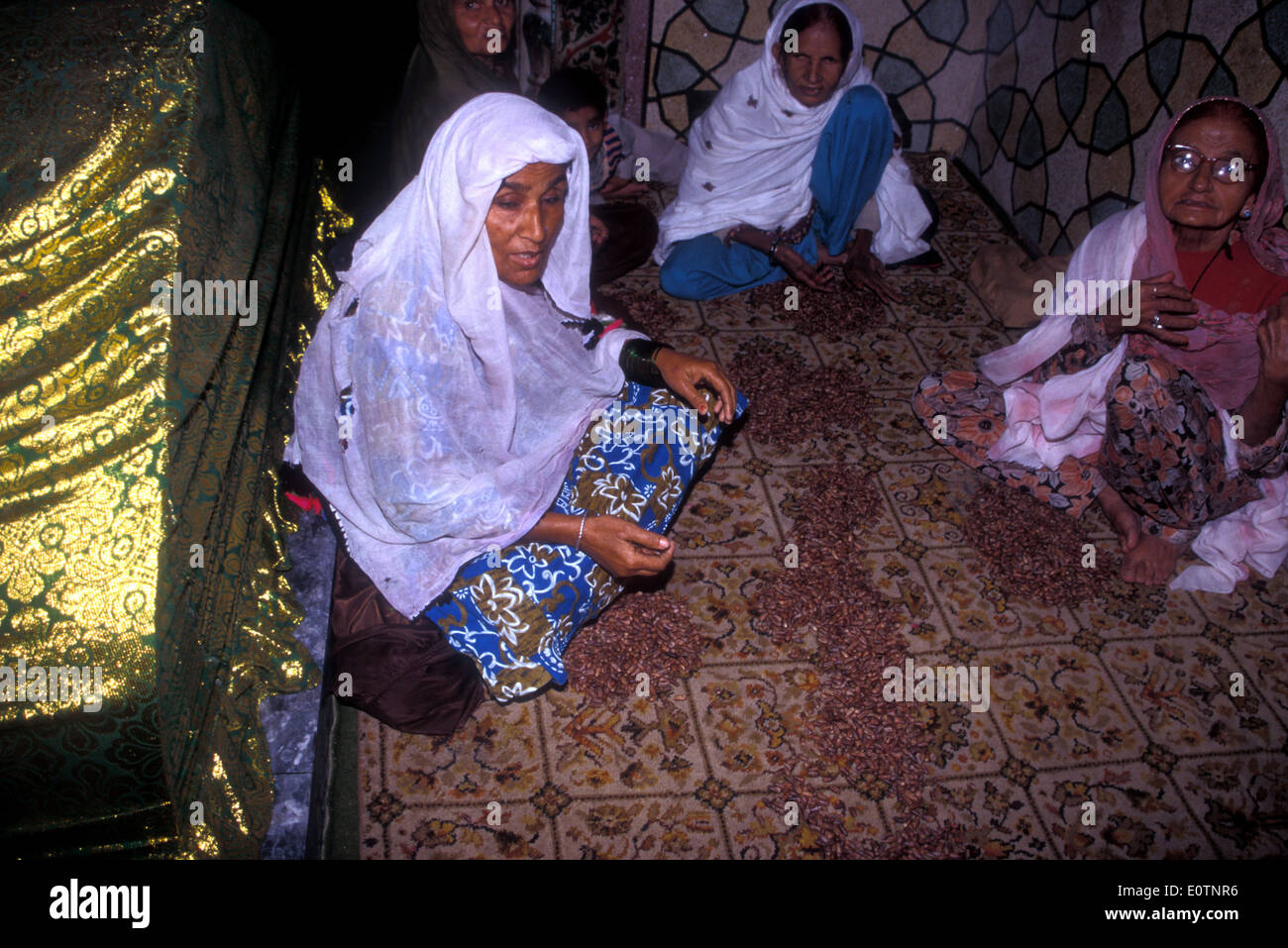 Poor women murids saying the 99 names of Allah using bean seeds inside ...