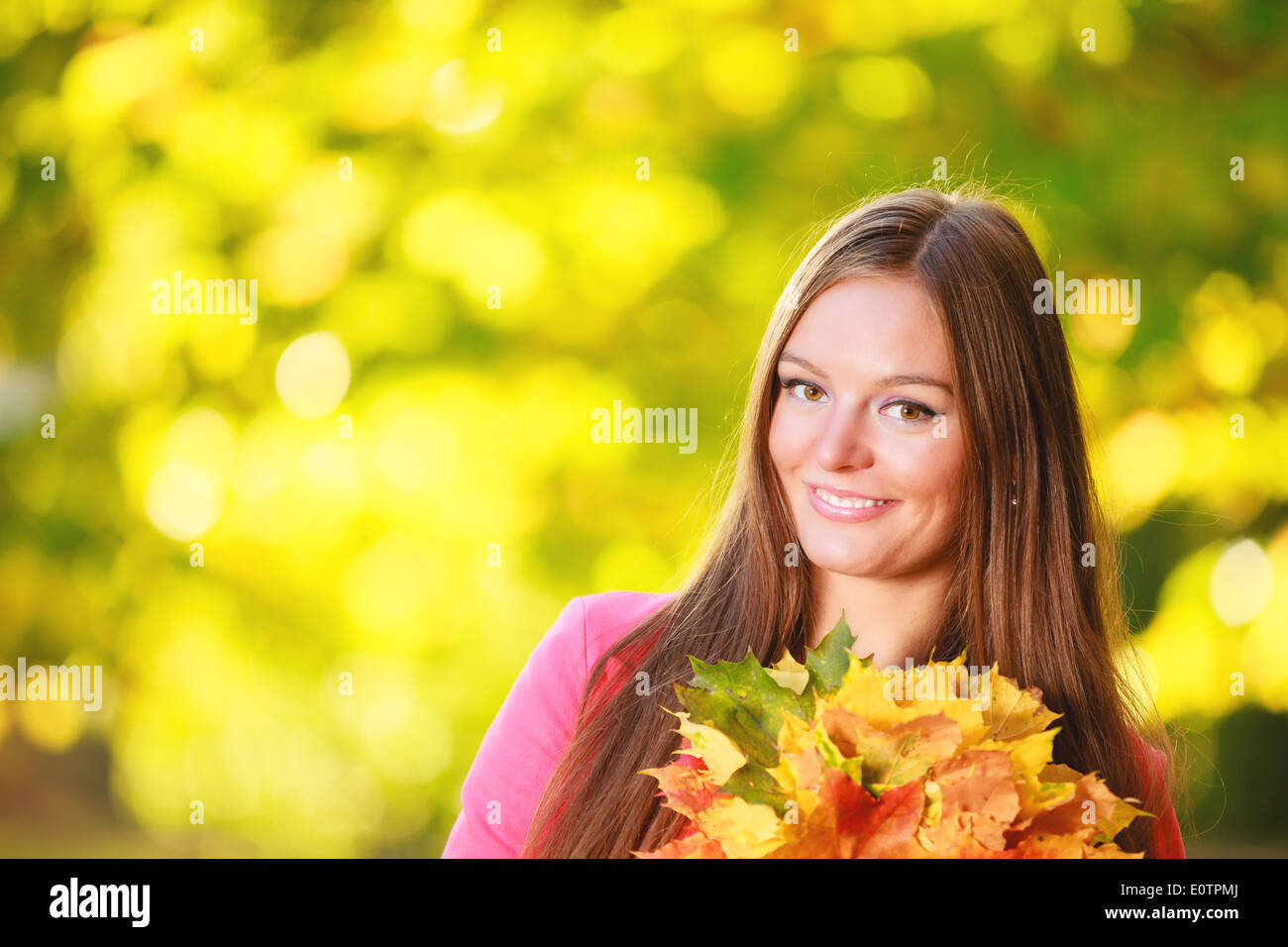 Fall season. Portrait of happy girl young woman with bunch of colorful ...
