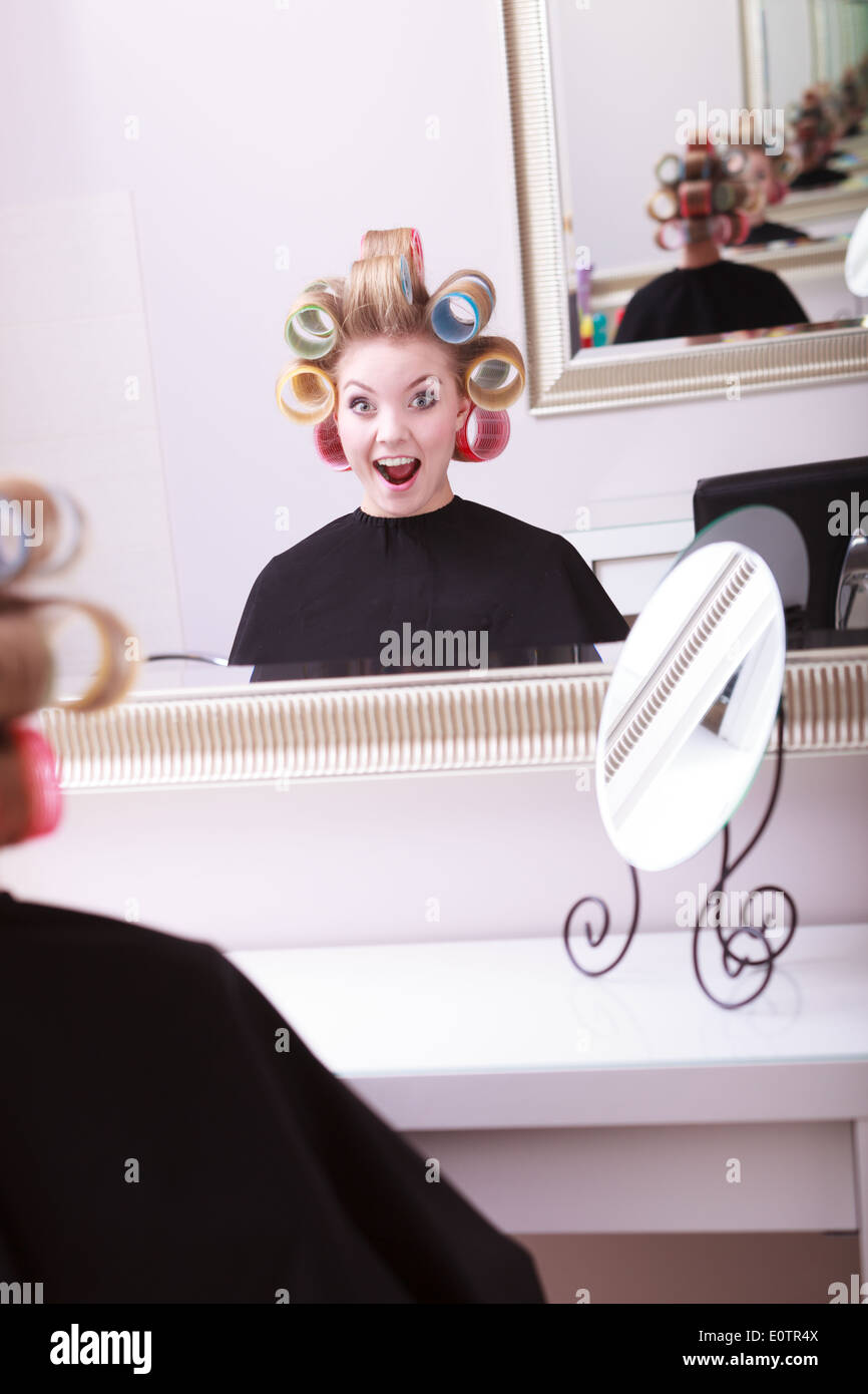 Portrait of funny happy woman in beauty salon. Cheerful blond girl with ...