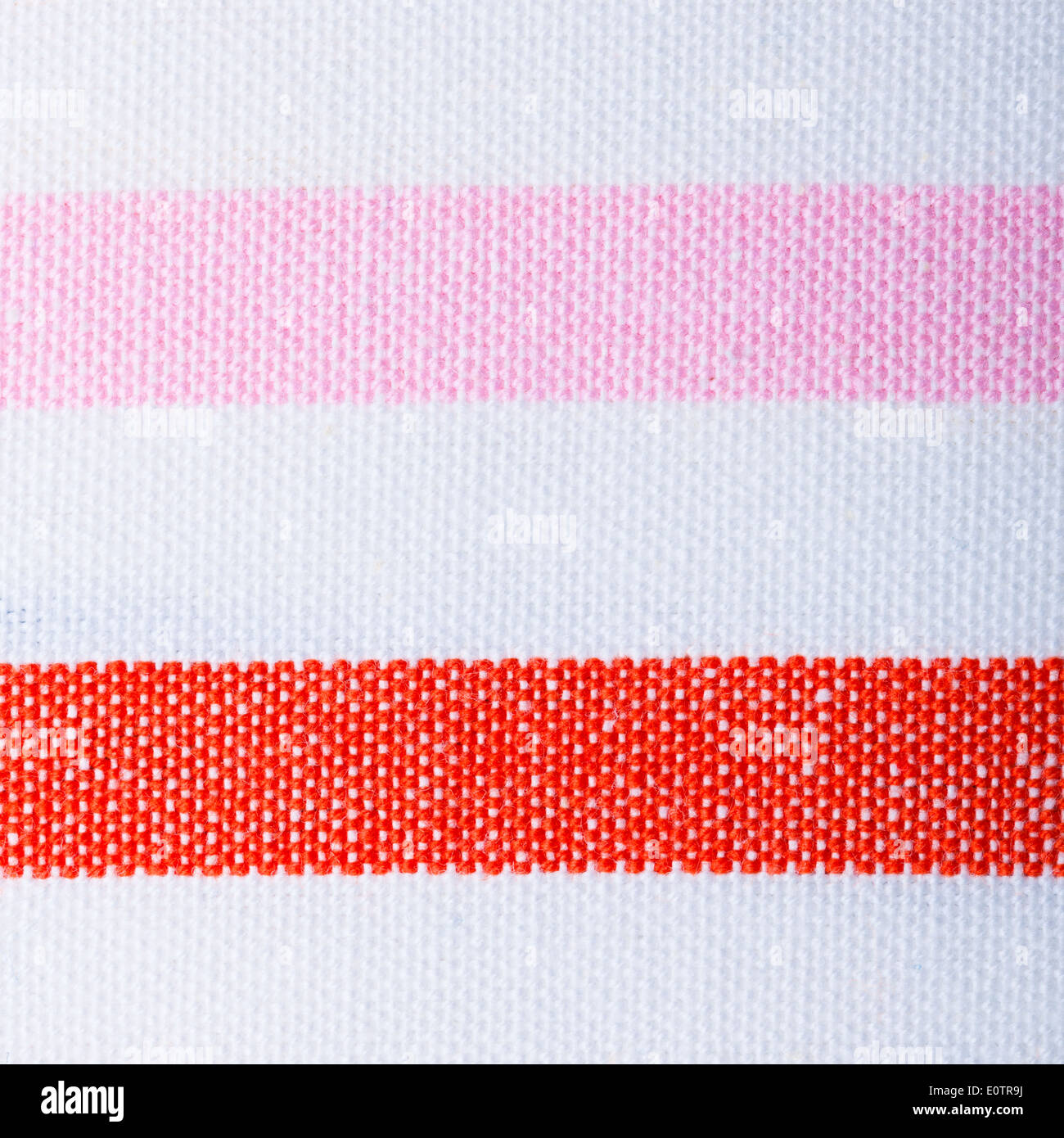 Closeup of colorful red pink white horizontal striped fabric textile as ...