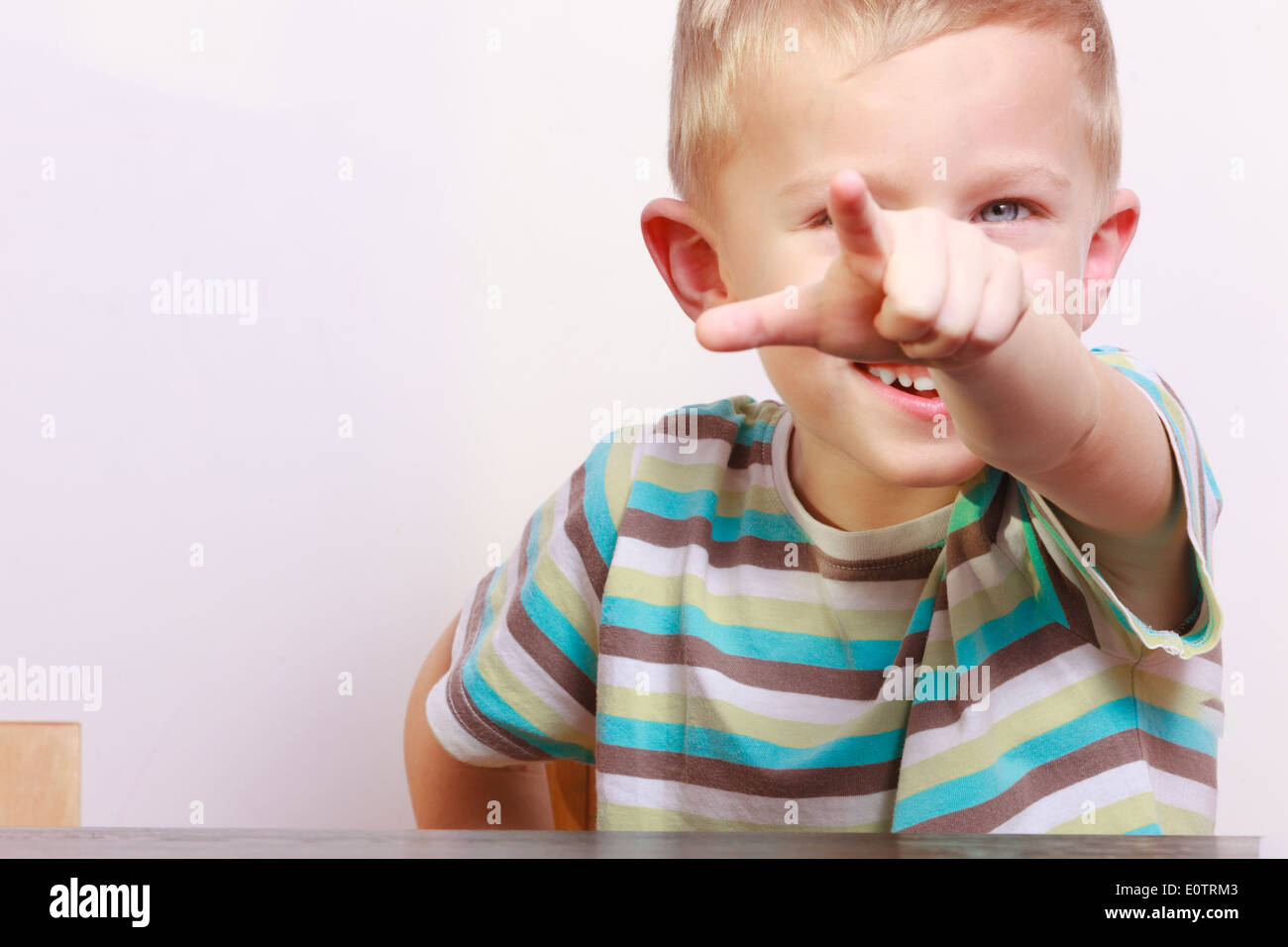 Portrait of happy blond cute boy child kid showing pointing at you at ...