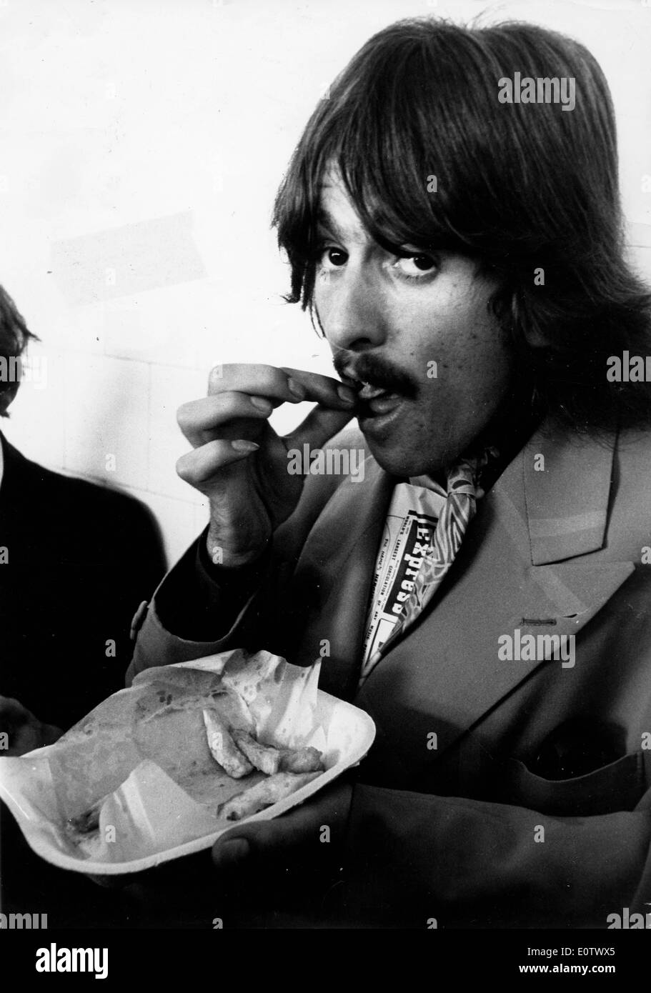 Beatle George Harrison enjoys a meal Stock Photo - Alamy