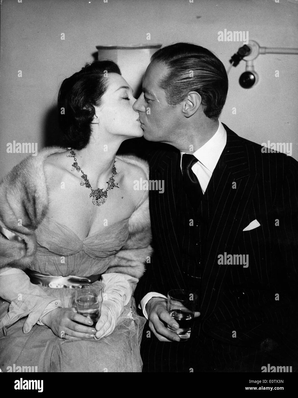 Actors Rex Harrison and Lilli Palmer kiss at a party Stock Photo - Alamy