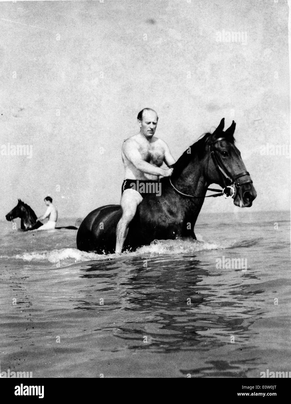 Harry Llewellyn riding a horse through the water Stock Photo - Alamy
